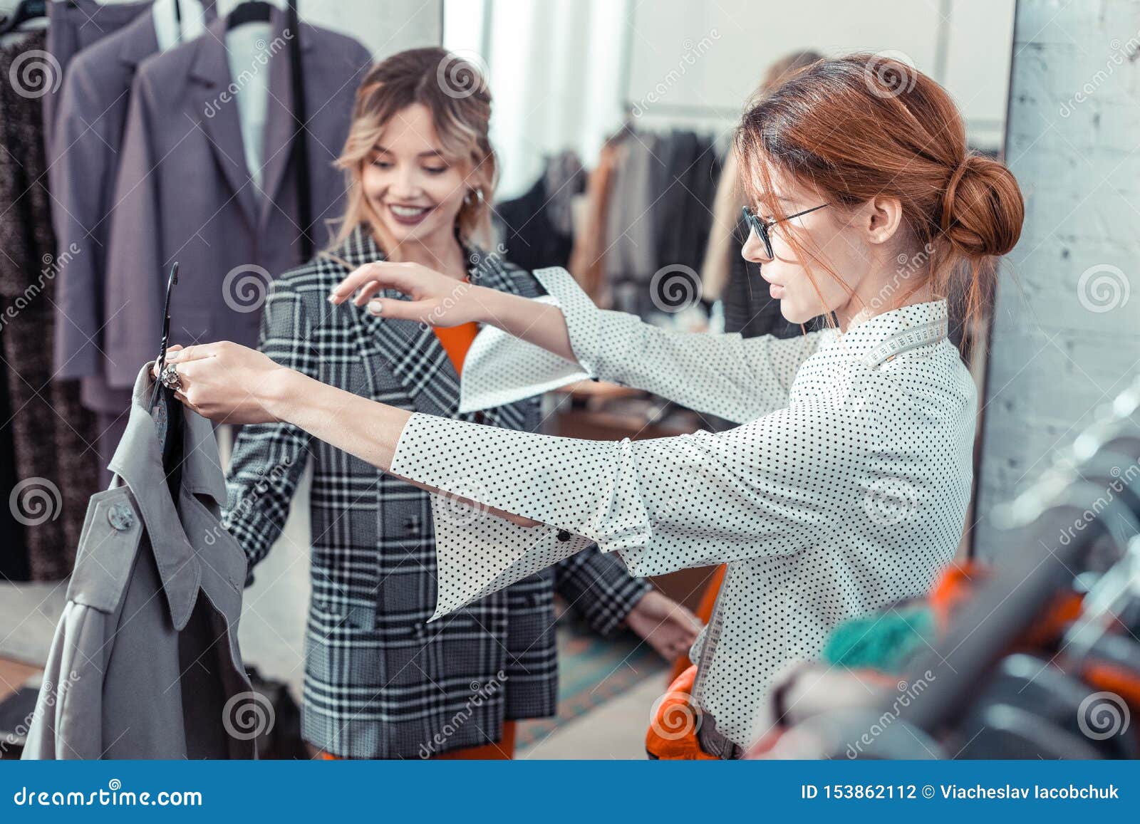 Shopping Assistant in Glasses Showing Client Nice Coat Stock Photo ...
