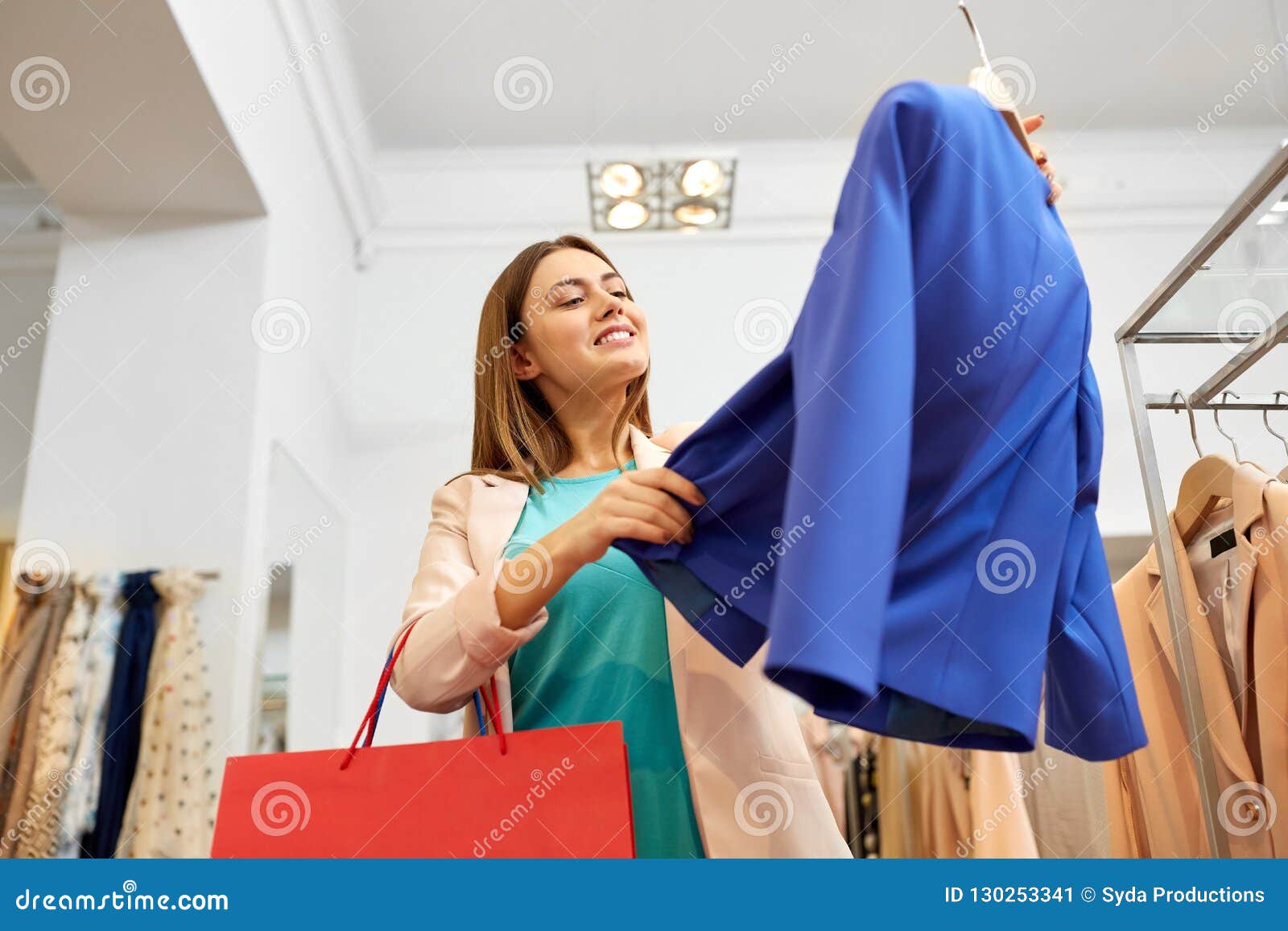 Happy Woman Choosing Clothes at Clothing Store Stock Image - Image of ... Happy Woman Choosing Clothes at Clothing Store Stock Image - Image of ...