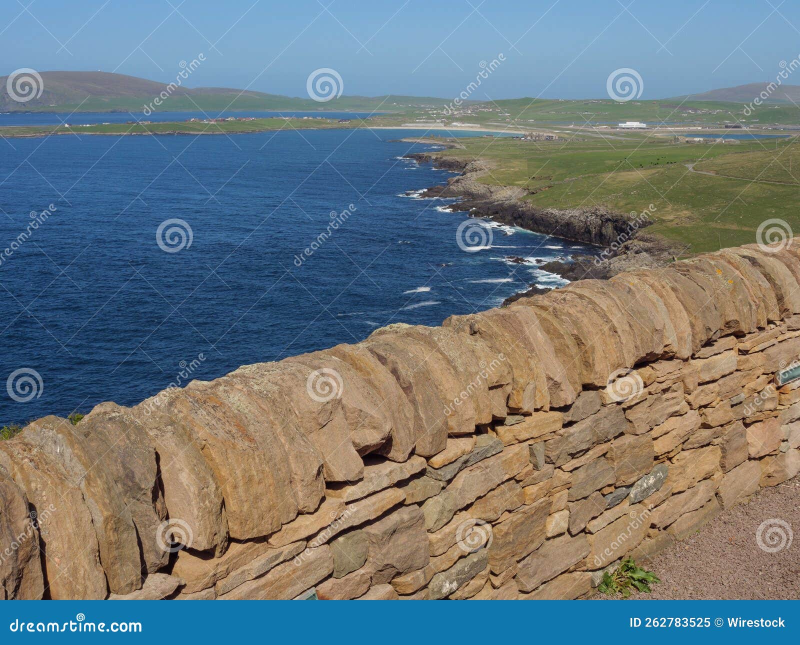 Shore Decorated with a Fence and Deep Blue Sea in the Background Stock ...