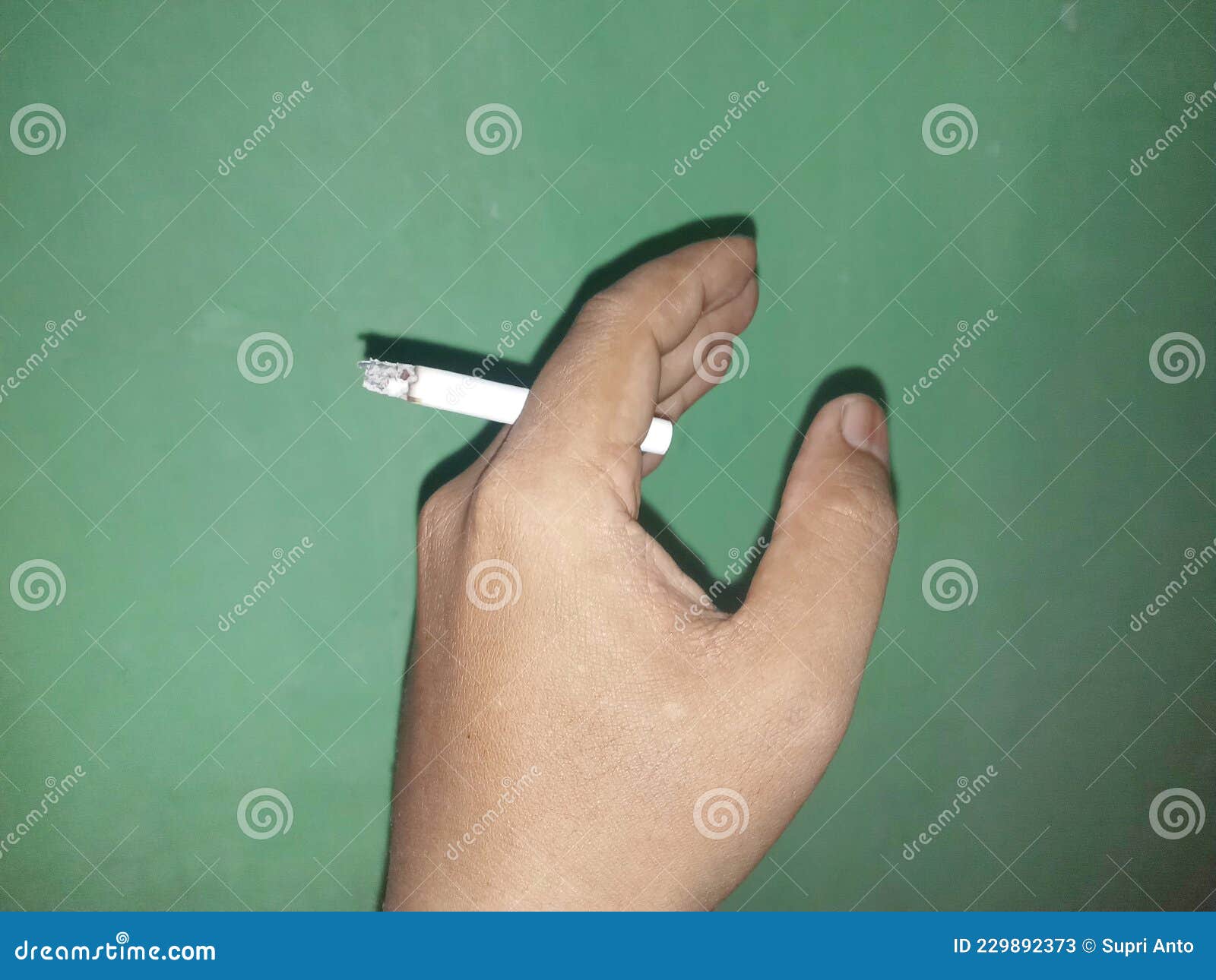 A short cigarette in hand stock image. Image of short - 229892373