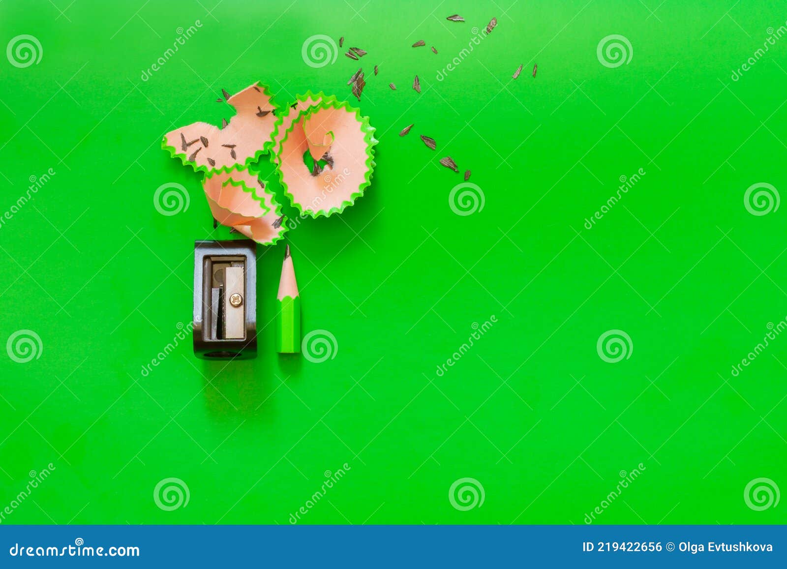 A Short Green Pencil Sharpened with a Sharpener, Shavings on a Green ...