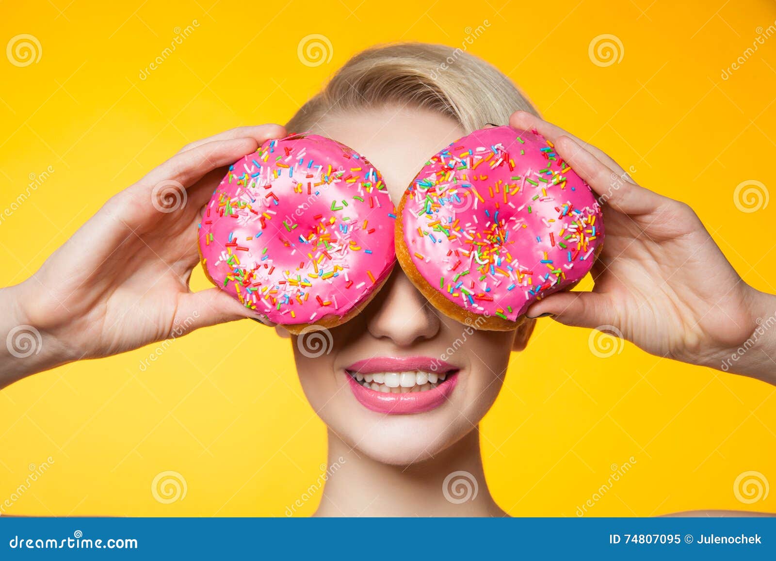 Short-haired Model Covering Eyes Behind Two Pink Donuts Stock Image ...