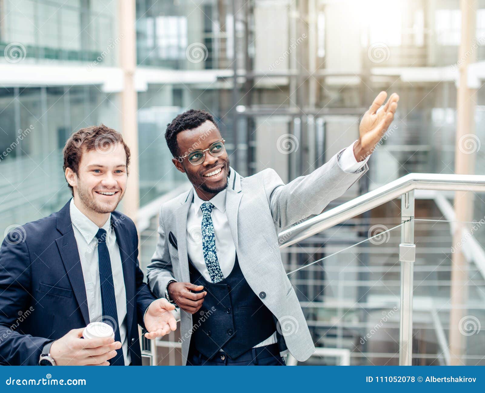 Afroamerican Estate Agent with Potential Clients Inside an Empty Office ...