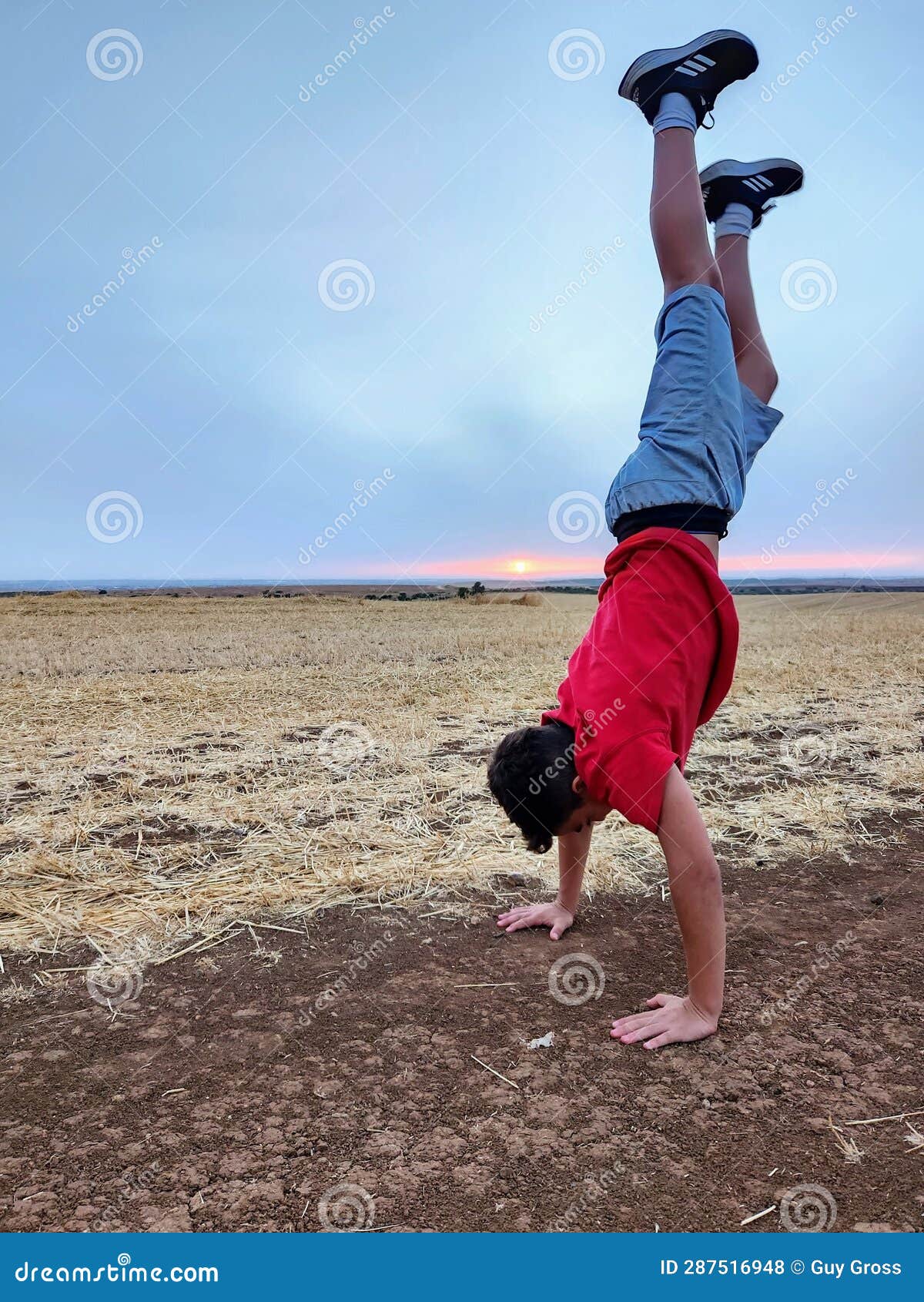 A Shot of a Boy Doing a Handstand in the Countryside. Stock Photo ...