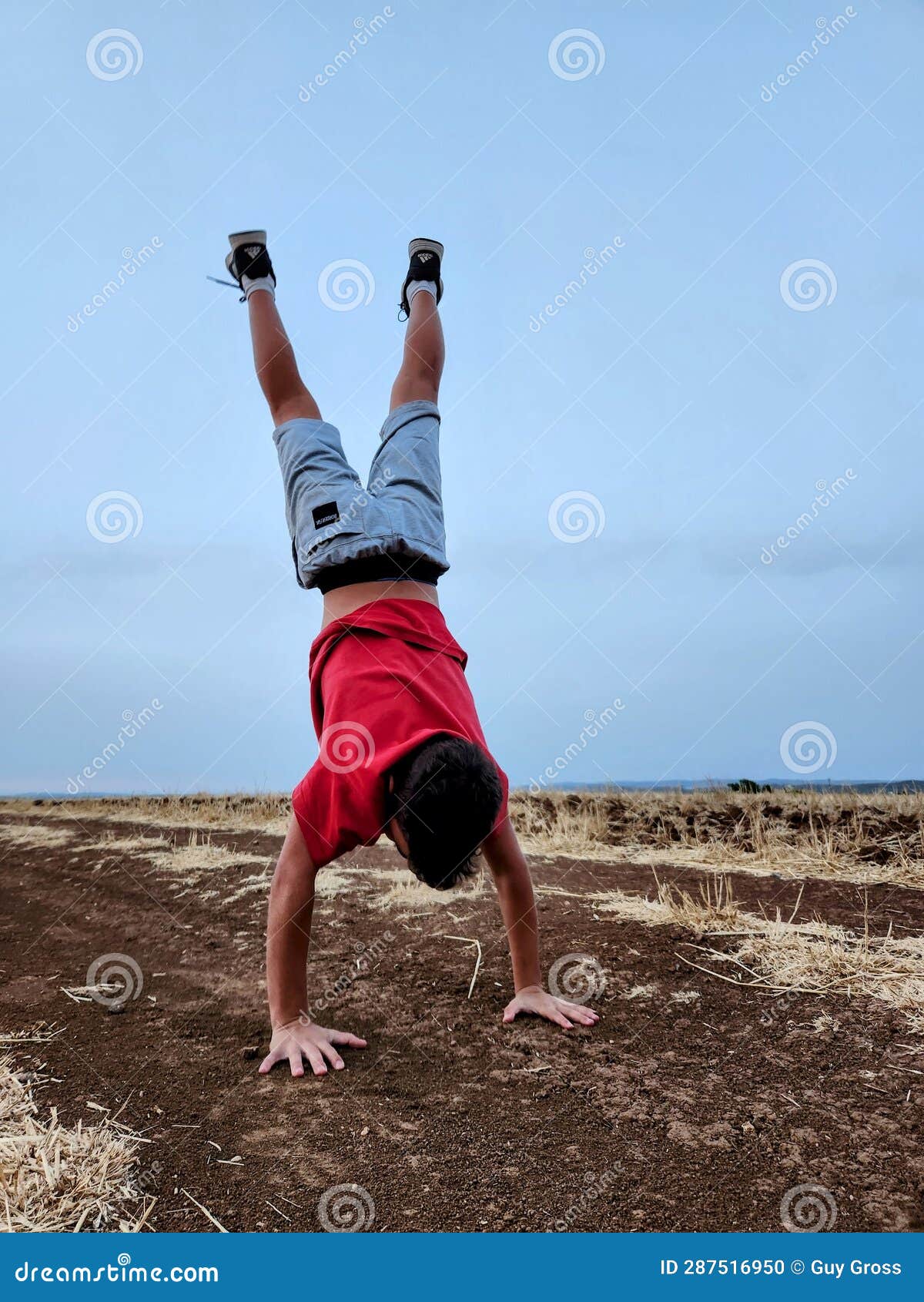 Shot of a Boy Doing a Handstand in the Countryside. Stock Photo - Image ...
