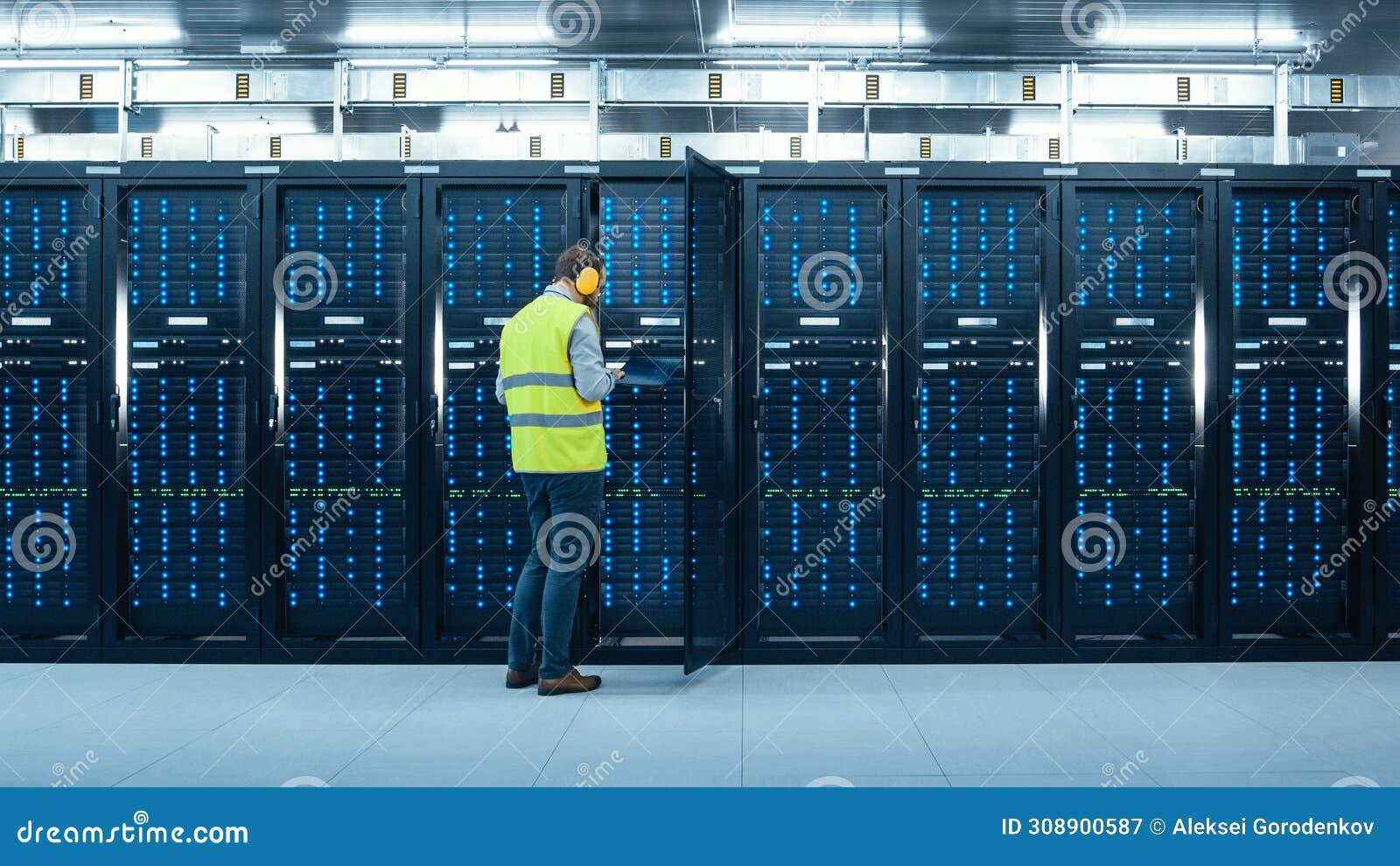 Shot of an it Engineer in High Visibility Vest and Headphones Working ...