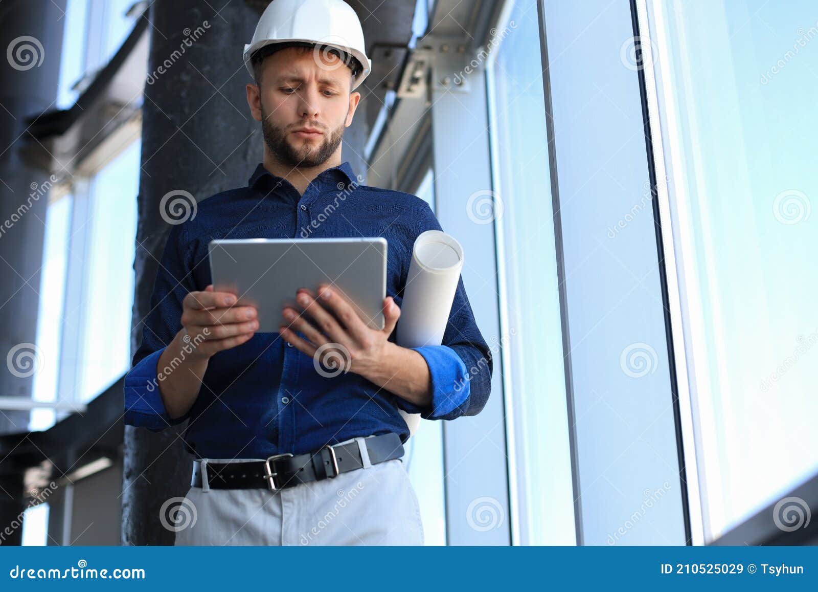 Shot of a Engineer Using a Digital Tablet on a Construction Site. this ...