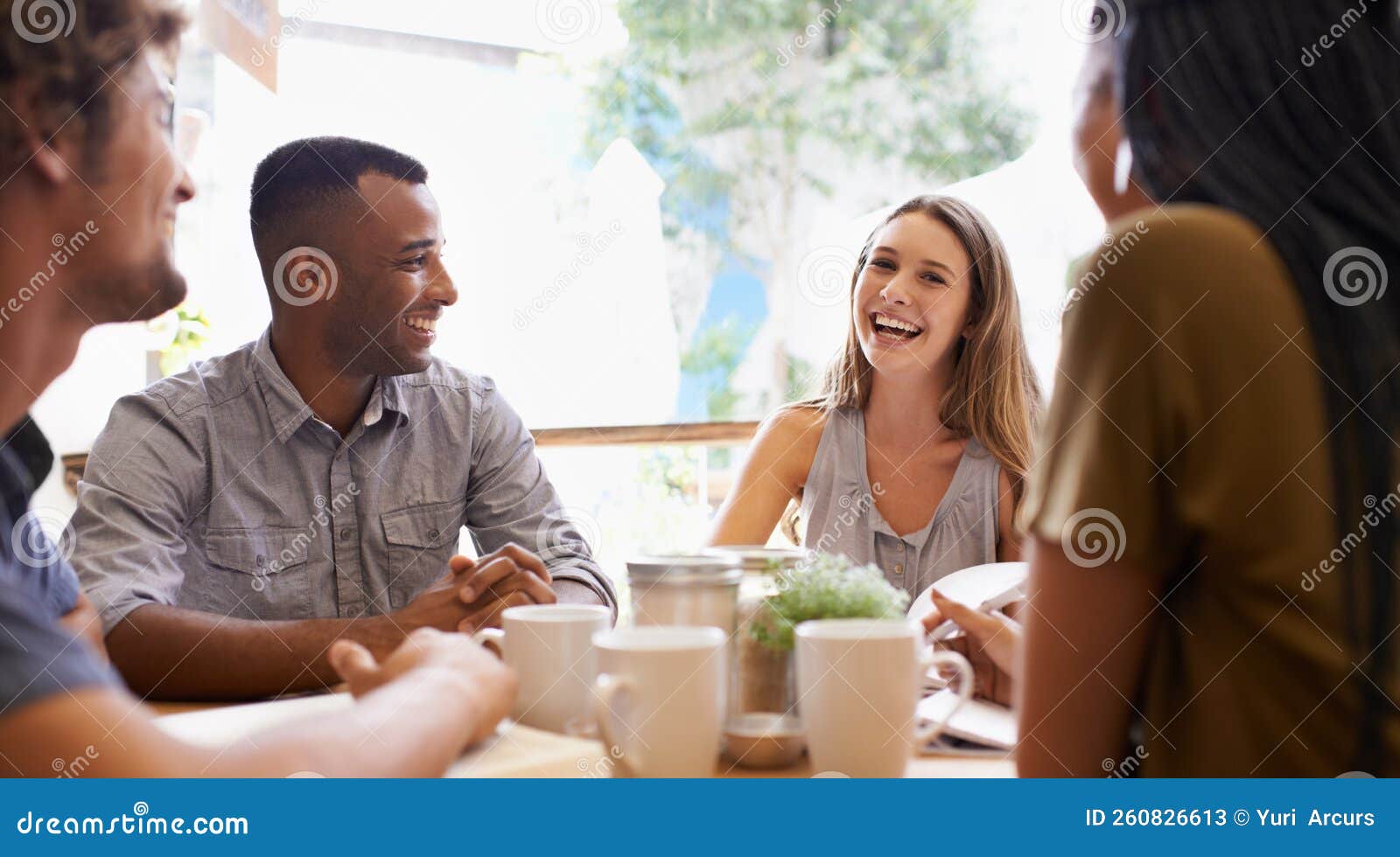 Catching Up with Old Friends. Shot of a Group of Friends Talking in a ...