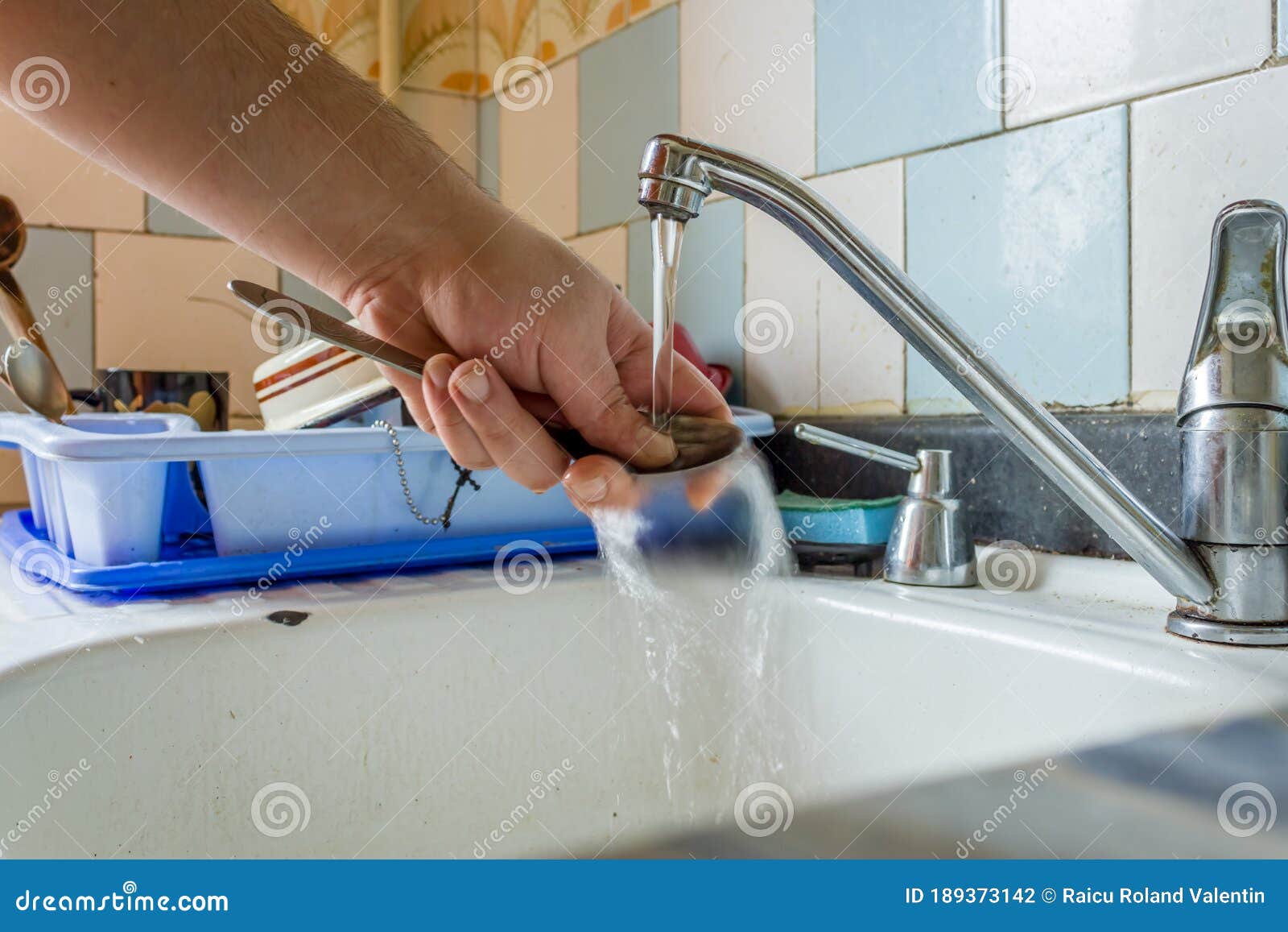 Human hand washing a spoon stock photo. Image of detergent - 189373142