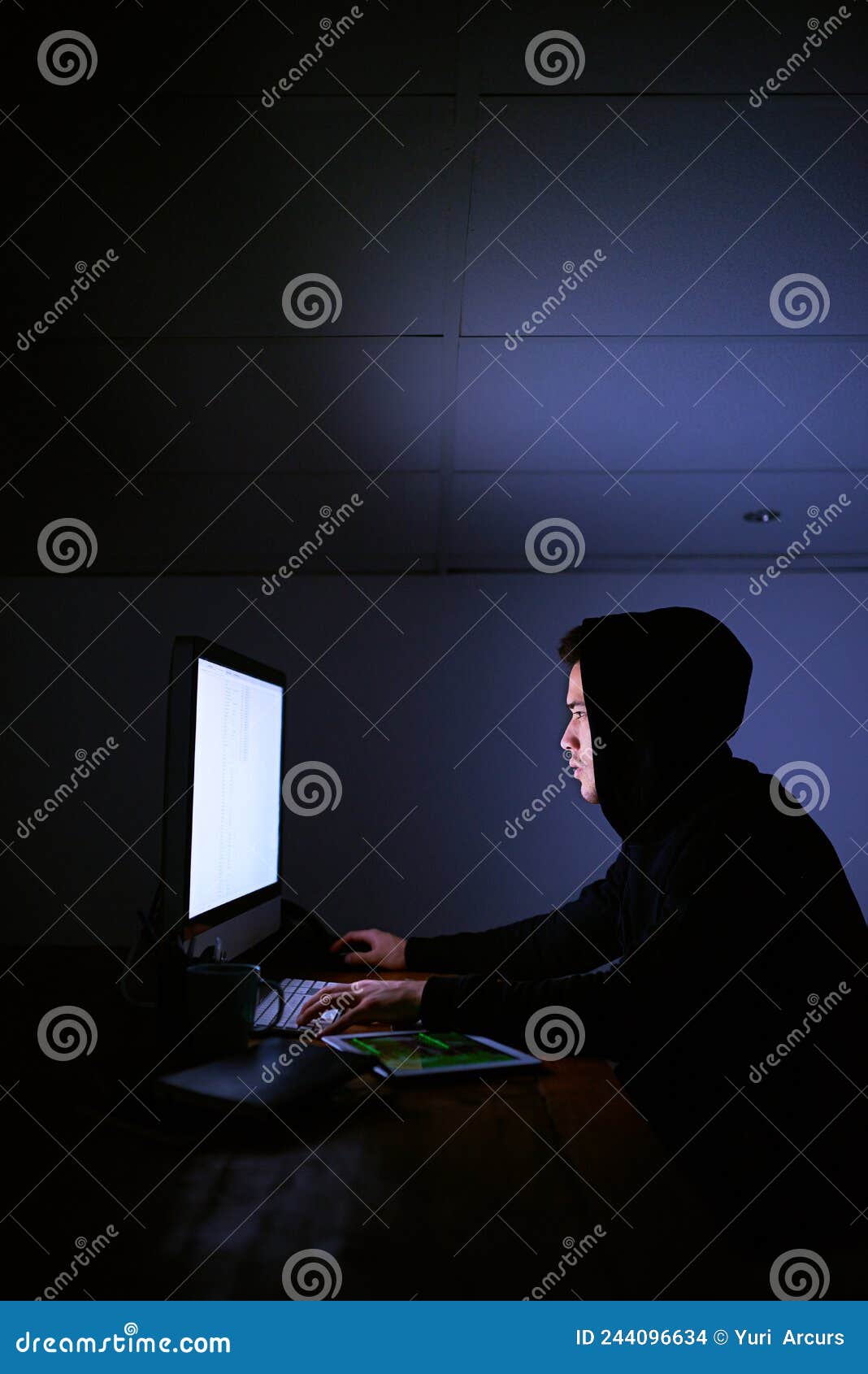 Scouring the Net for His Next Victim. Shot of a Hooded Computer Hacker ...