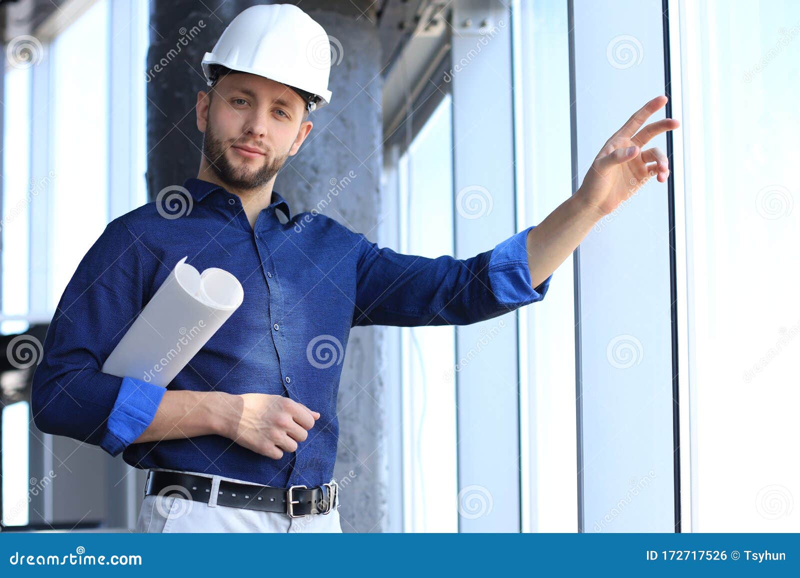 Shot of Male Architect Wearing Hardhat and Inspecting New Building ... Shot of Male Architect Wearing Hardhat and Inspecting New Building ...