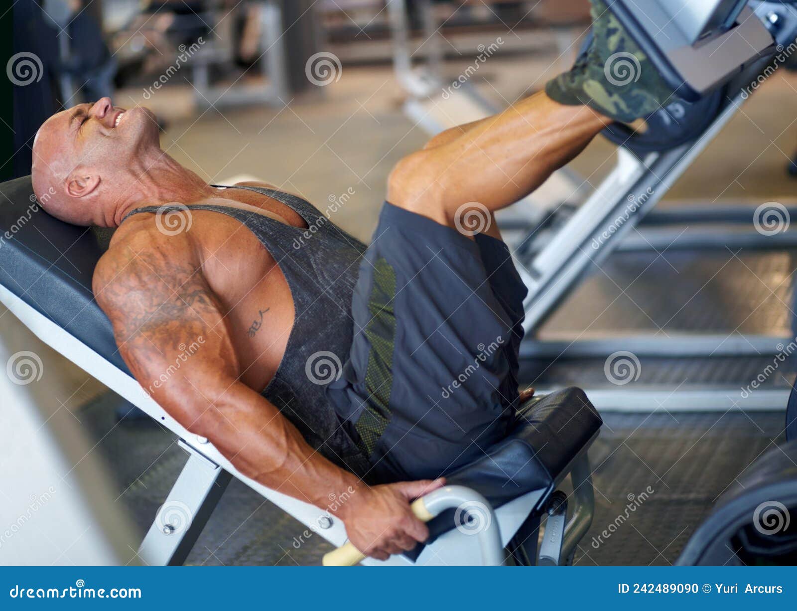Feeling Determined. Shot of a Male Bodybuilder Doing Leg Exercises on a ...