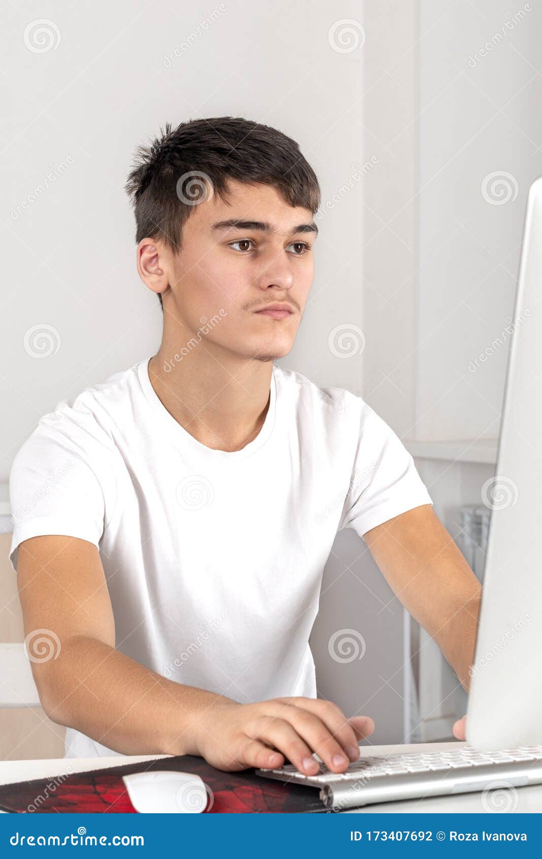 Shot of a Serious Teenager Guy Using Computer Stock Photo - Image of ...