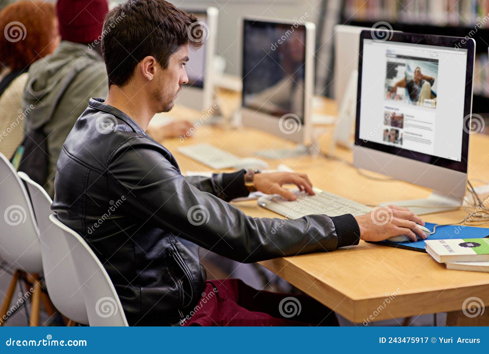 Gathering Facts Online. Shot of Students Working on Computers in a ...