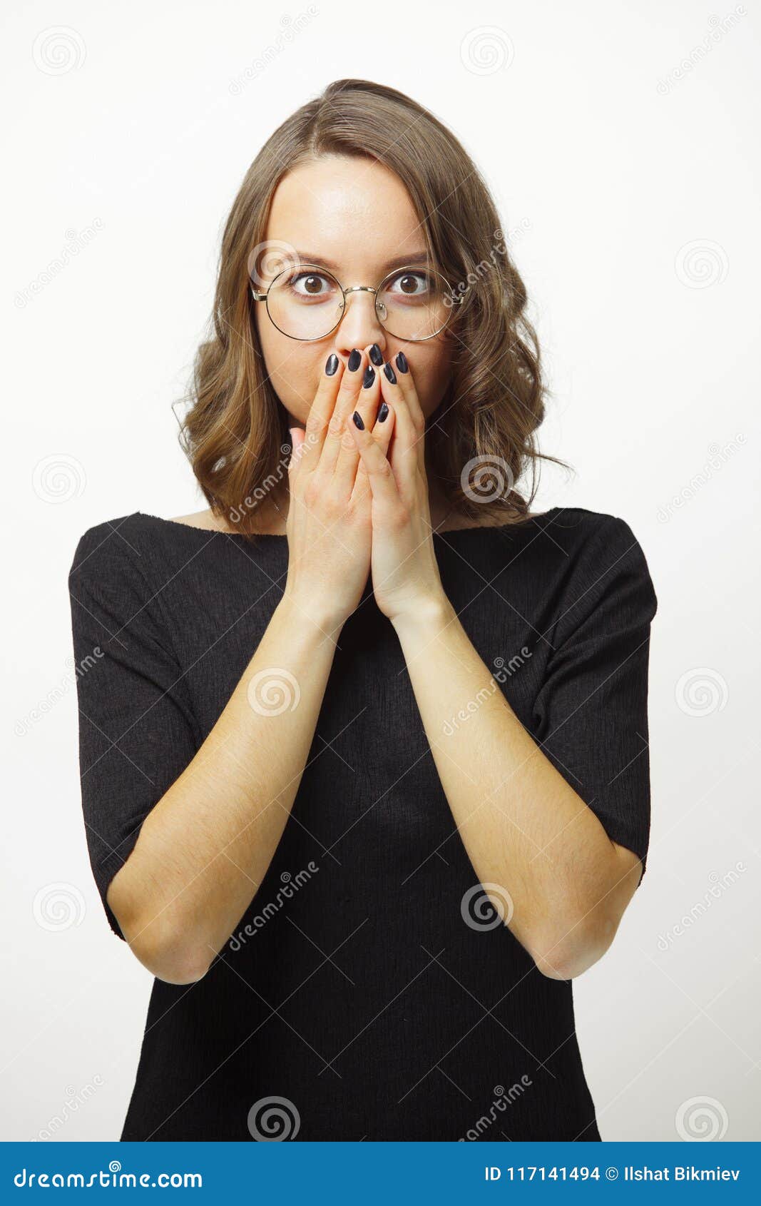 Shot Of Stunned Woman Covers Her Mouth With Hands Wears Round Spectacles Has Shocked