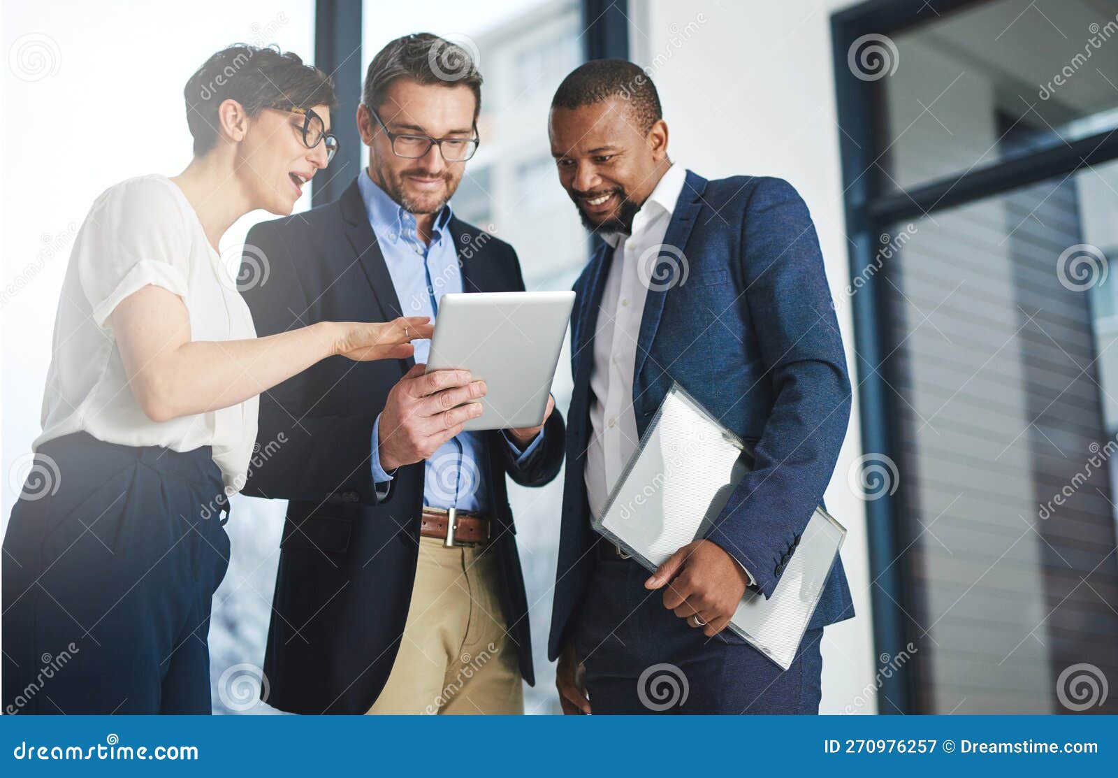 Digitizing Business Discussions. Shot of a Team of Colleagues Using a ...