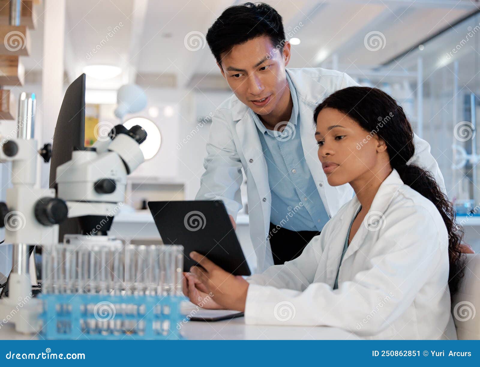 Double the Brain Power. Shot of Two Lab Techs Working Together while ...