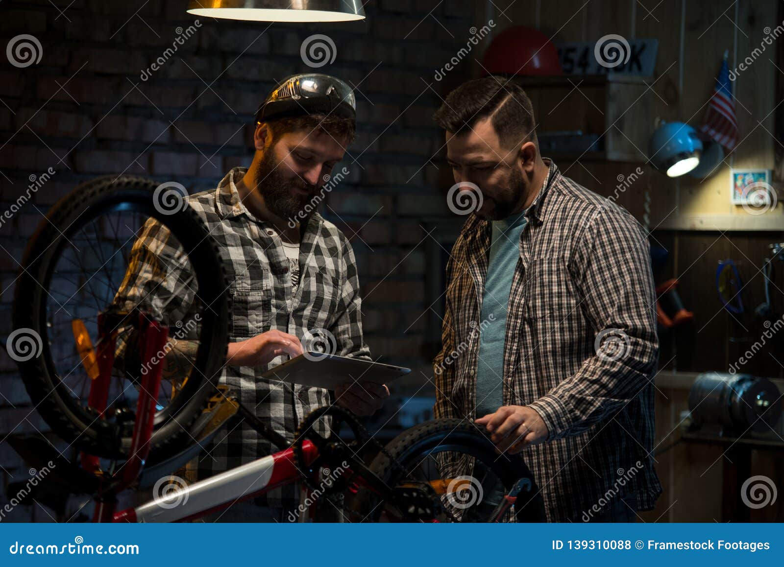Two Mechanic Talking in a Workshop Stock Photo - Image of bicycle ...