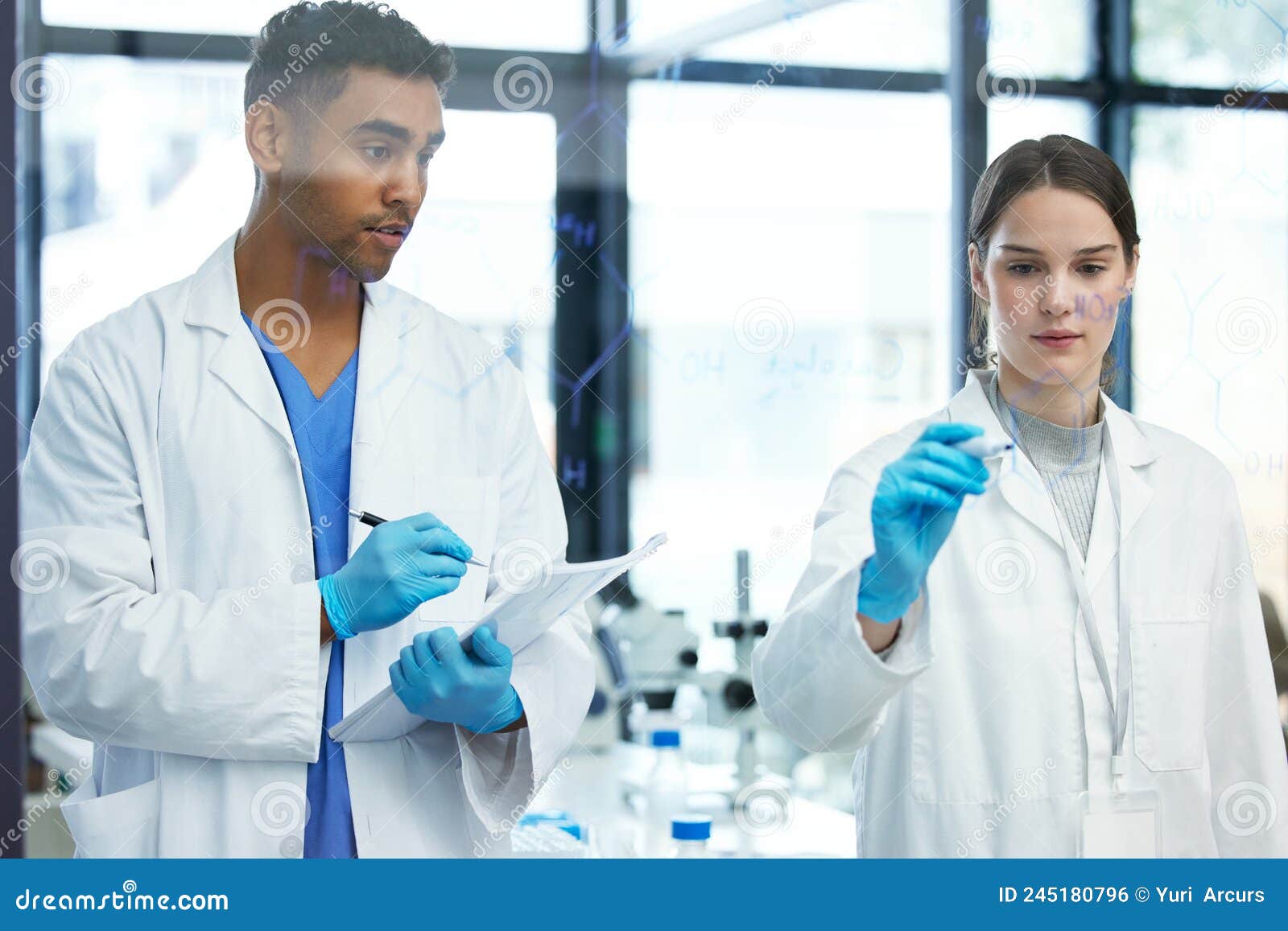 Doing the Maths To Prove Their Theory. Shot of Two Scientists Solving ...