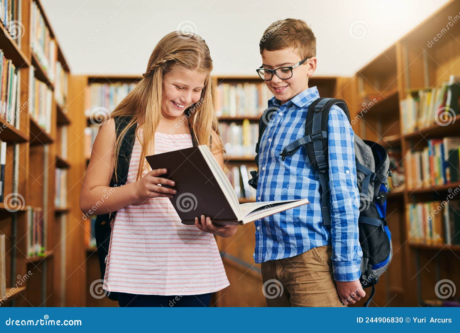 Knowledge is Power. Shot of Two Young School Children Reading a Book ...