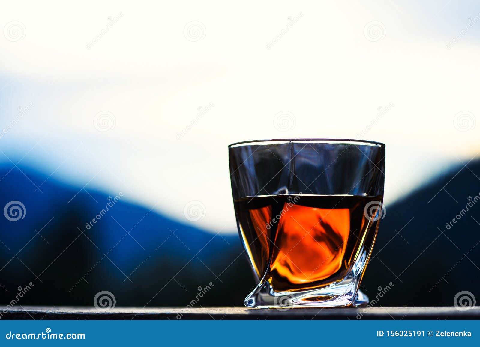 Shot of Whiskey at Sunset Dramatic Sky on Mountain Landscape Background ...