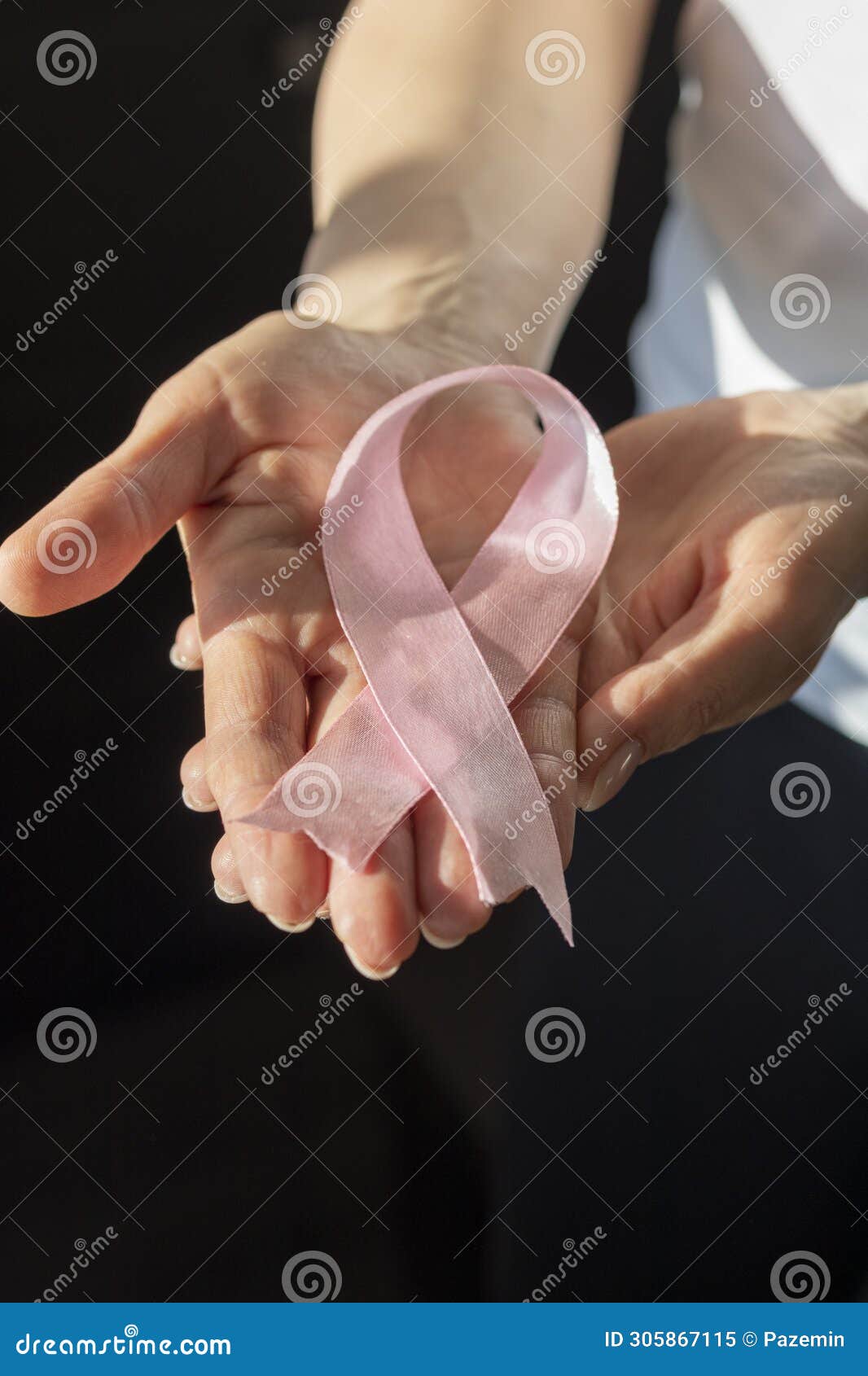 Shot Of A Woman Holding Pink Ribbon Symbol Of A Breast Cancer