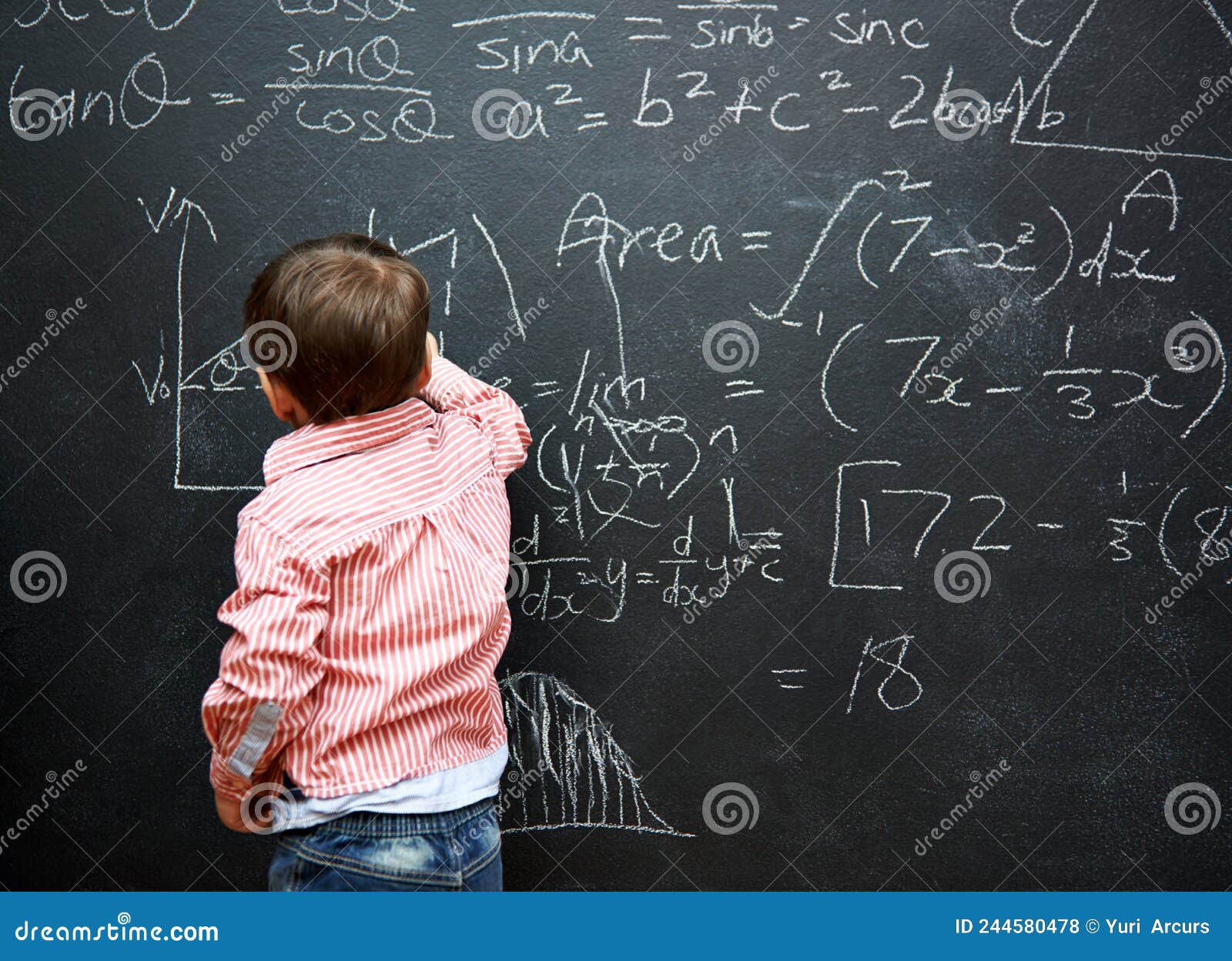 Mastering Math. Shot of a Young Boy with a Blackboard Full of Math ...
