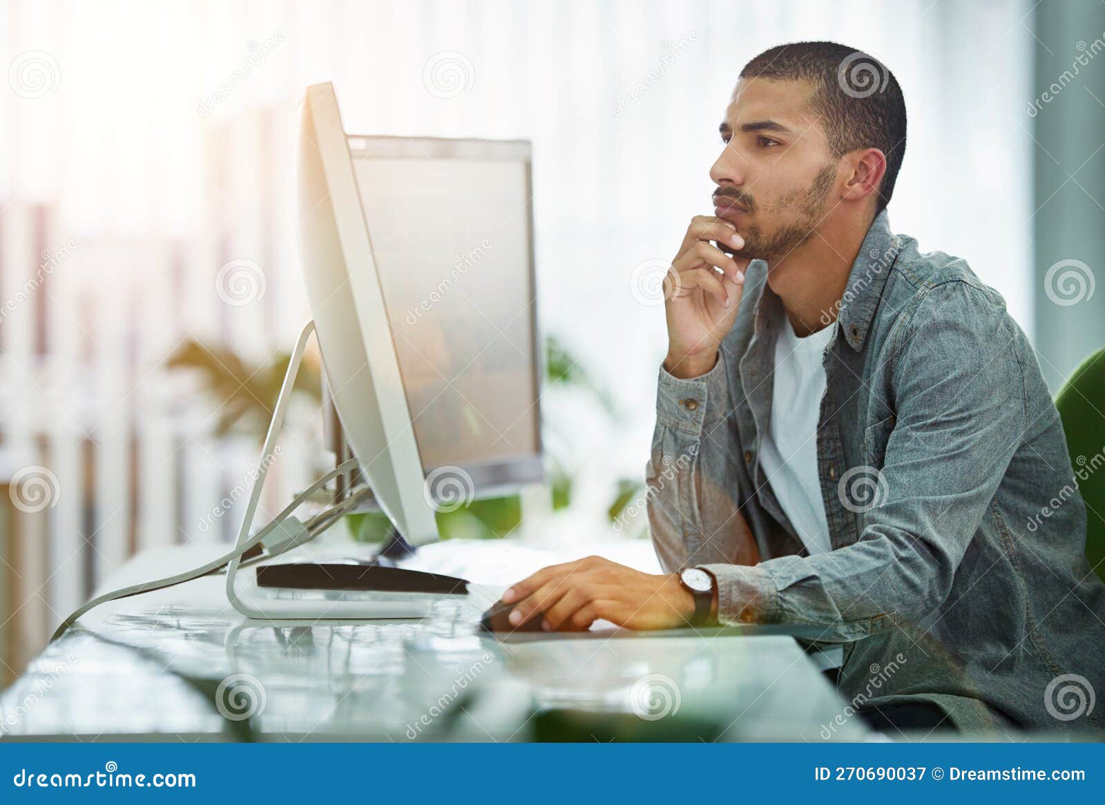 Problem Solving is His Specialty. Shot of a Young Designer Working at ...