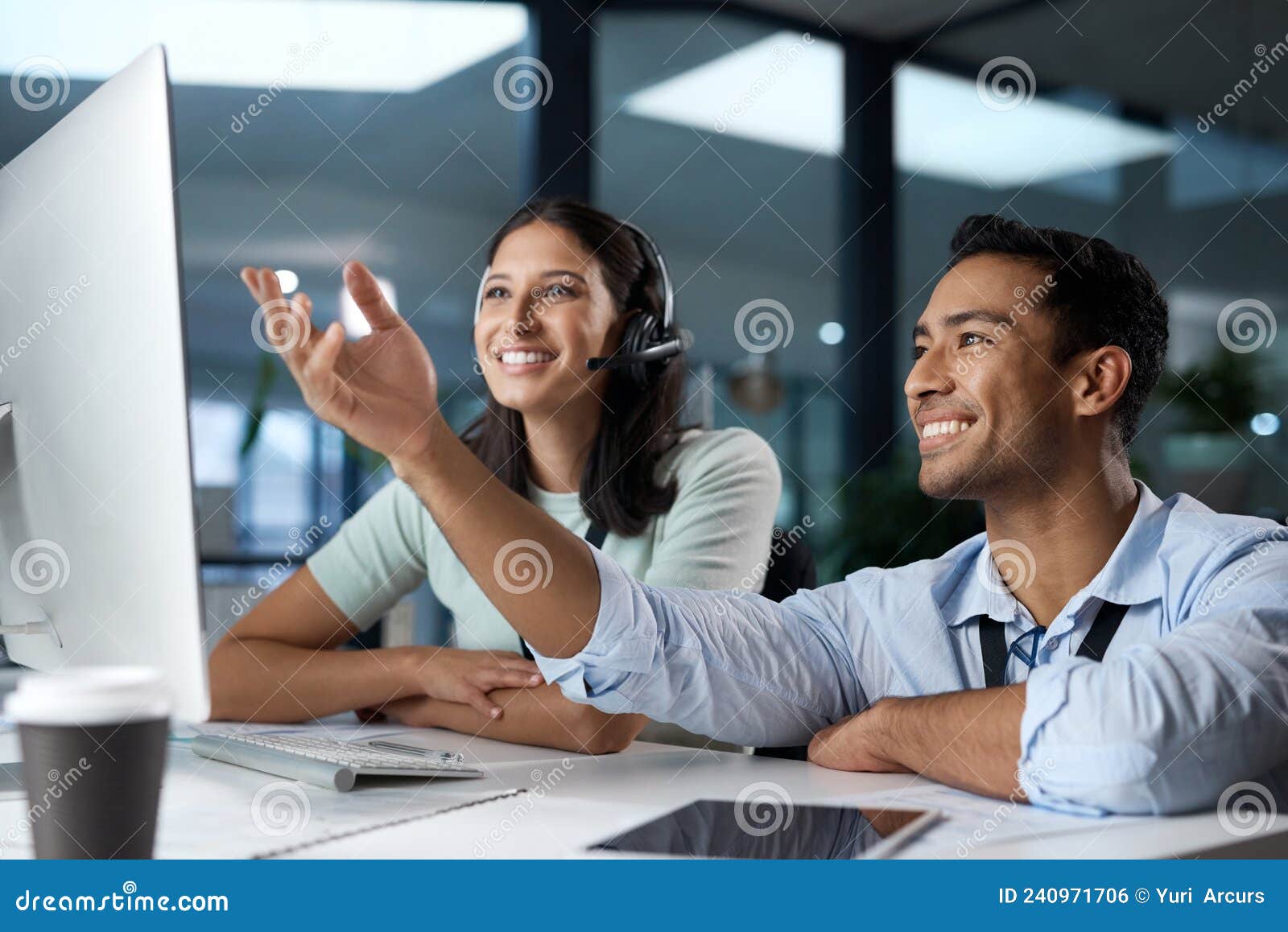 Teamwork Makes the Call Work. Shot of a Young Man and Woman Using a ...