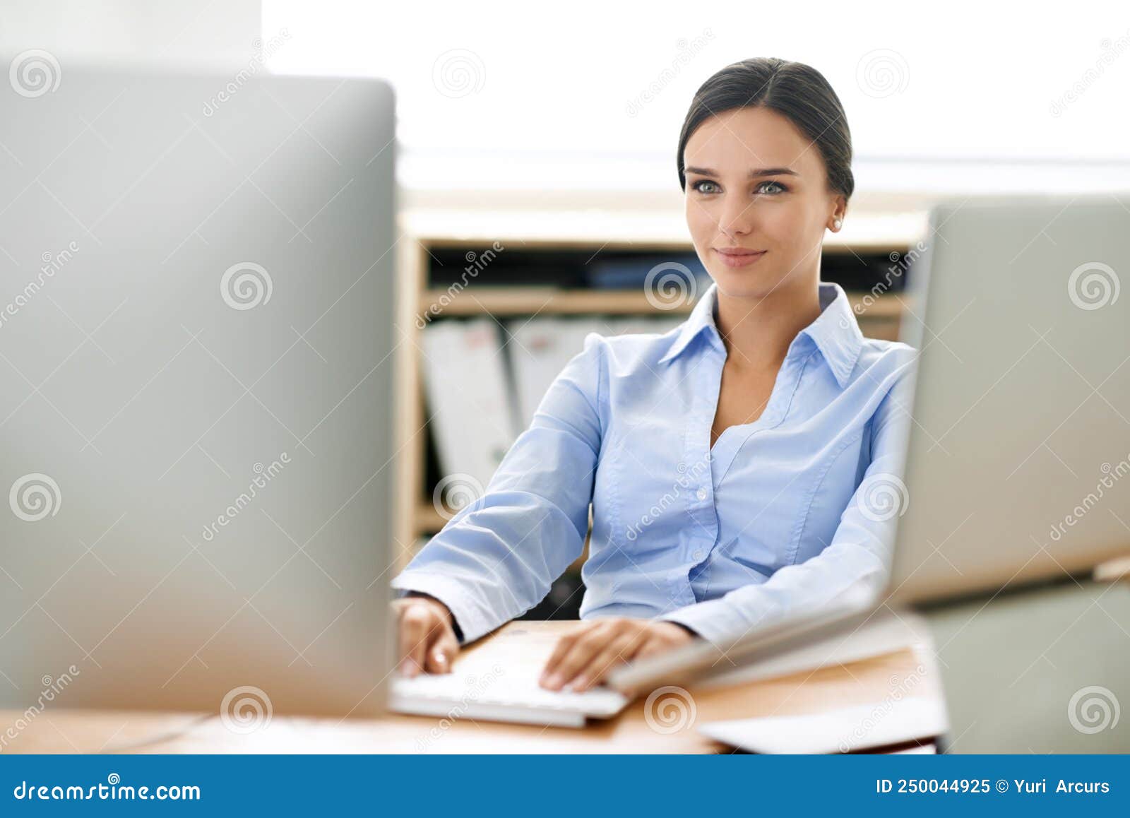 Never Too Far. Shot of a Young Office Professional Working at a ...