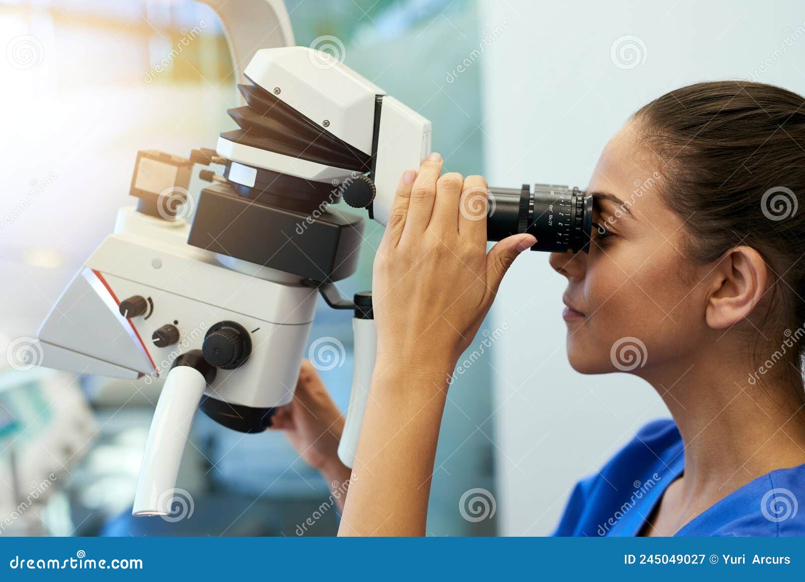 Taking a Closer Look. Shot of a Young Pathologist Looking at Samples ...