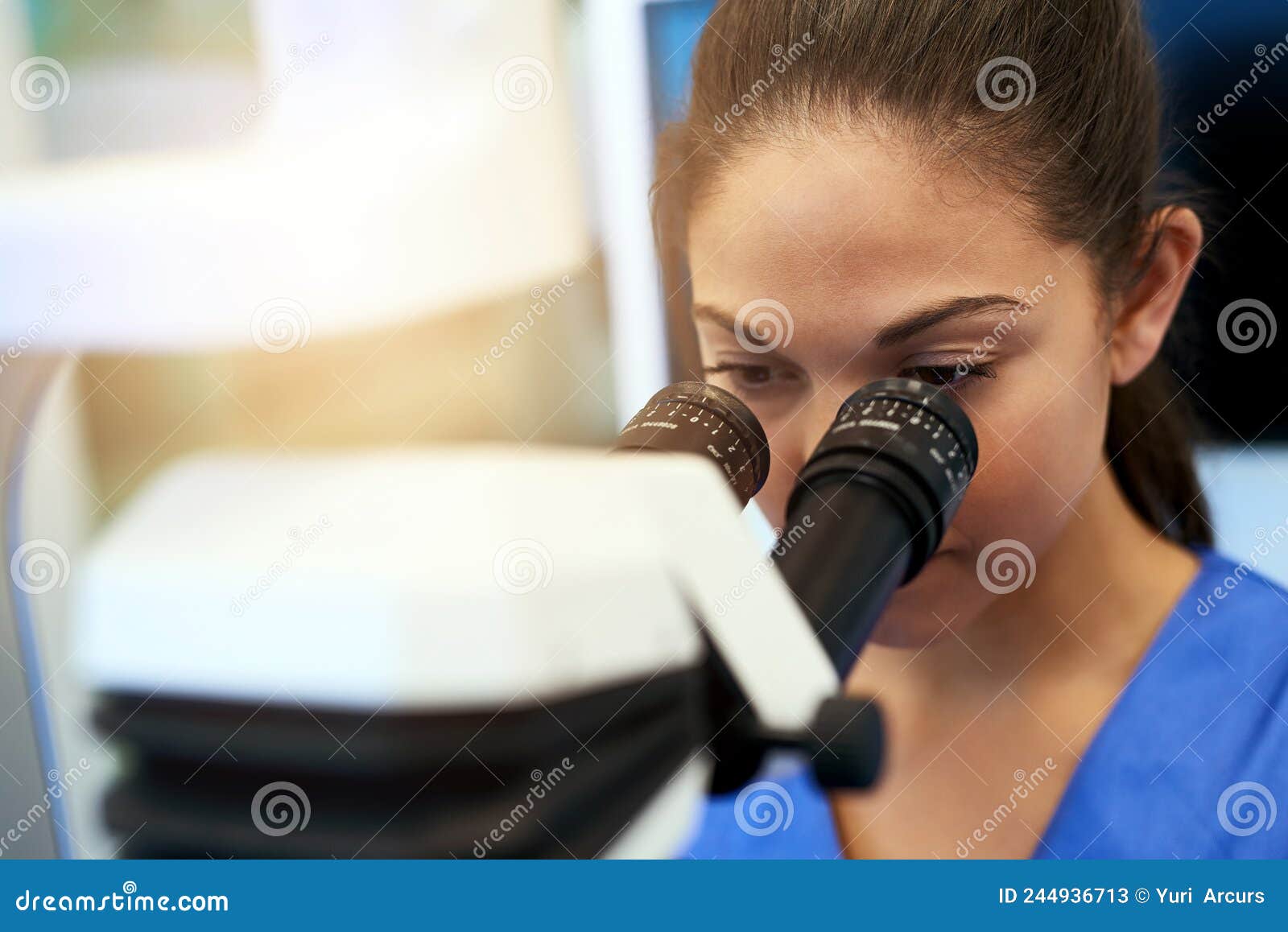 When Working with Microscopes, Focus is Key. Shot of a Young ...