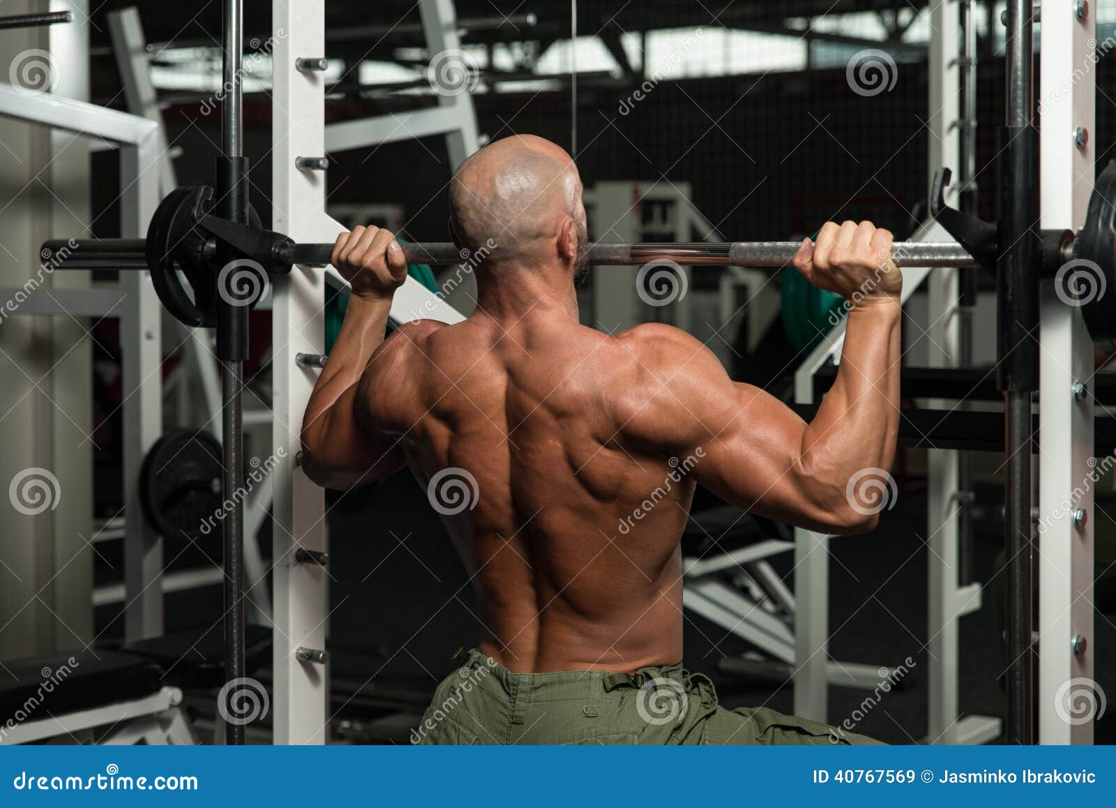 Shoulder Exercises on a Smith Machine Stock Image - Image of indoors ...