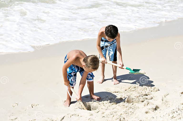 Shoveling Sand stock image. Image of young, ocean, beach - 6504125