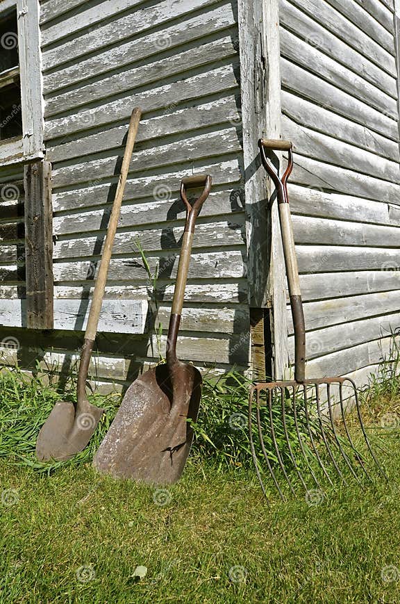 Shovels and Fork Along an Old Building Stock Photo - Image of lean ...