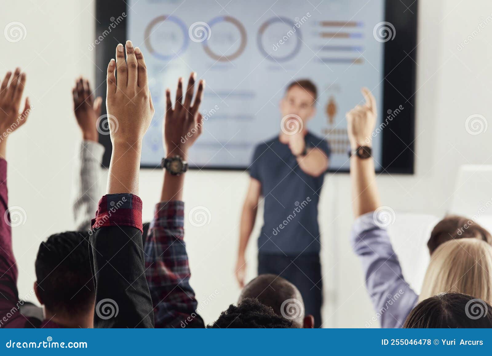 By a Show of Hands. a Group of People Raising Their Hands in a Class ...