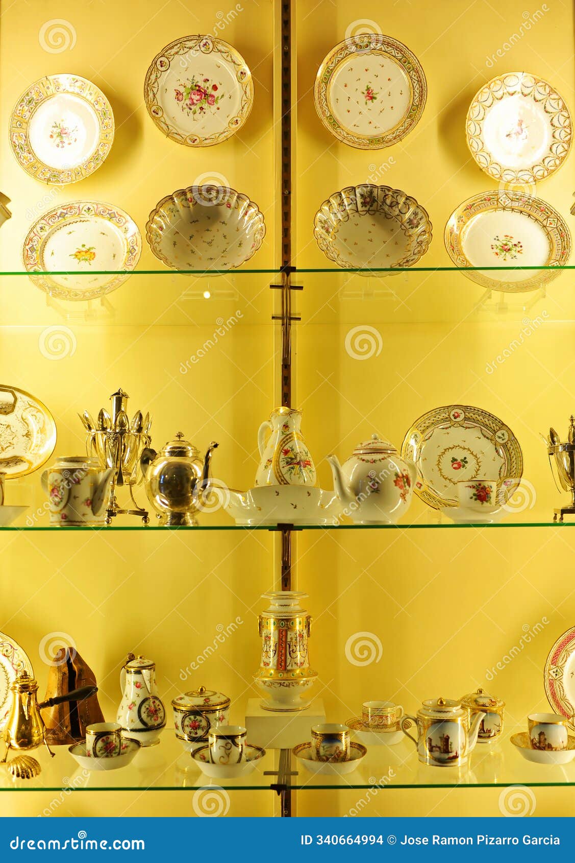 Showcase with Antique Porcelain Plates and Other Table Service Objects ...