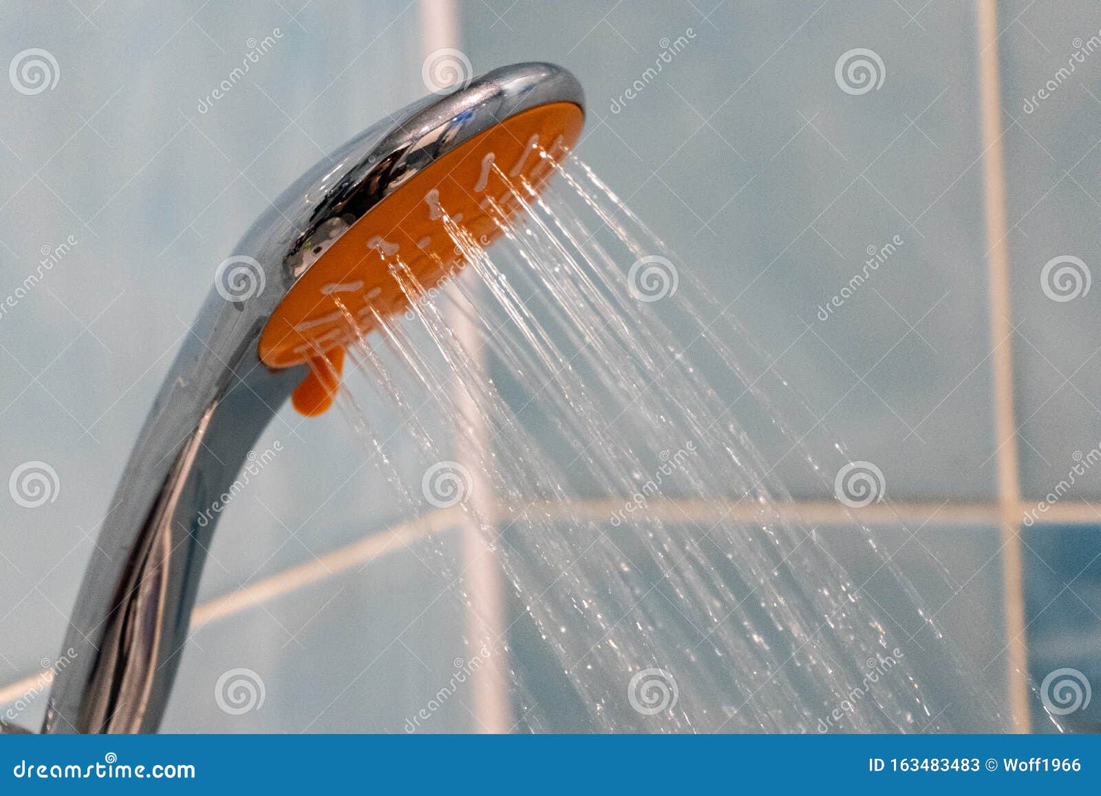 Shower with Running Water. Orange Shower on a Blue Tile Background ...