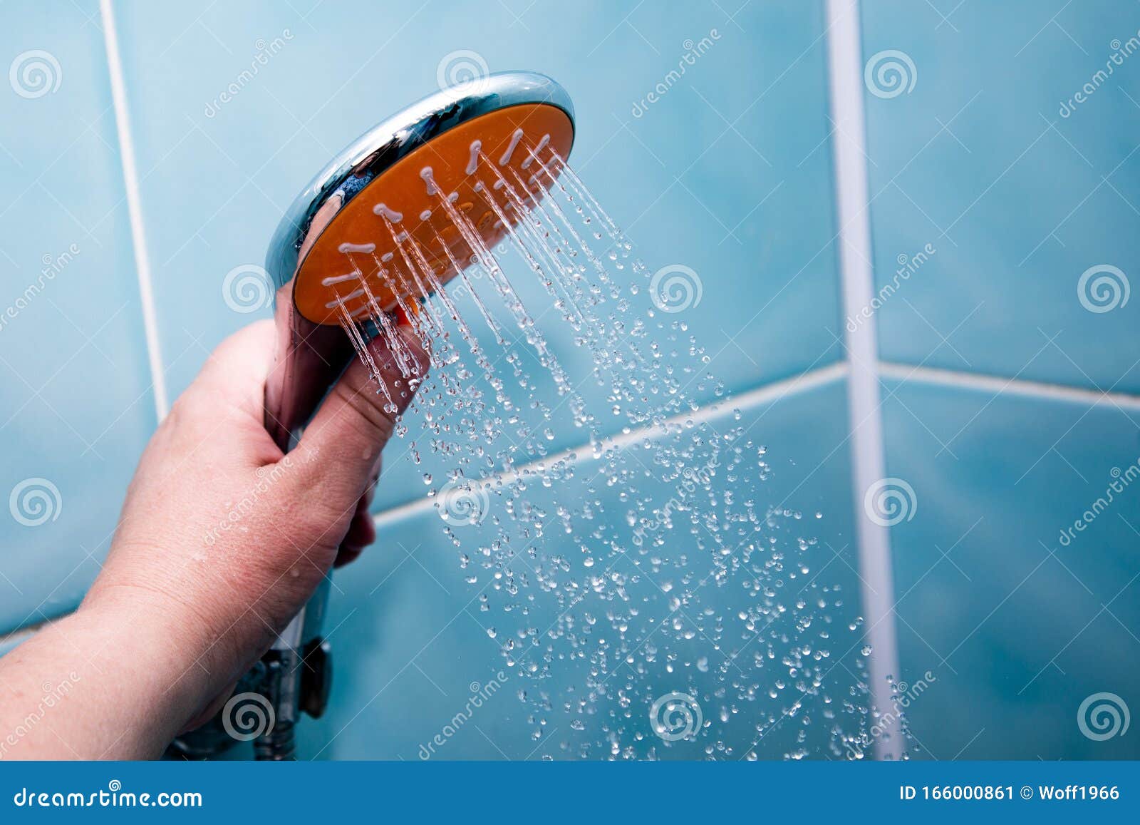 Shower with Running Water. Orange Shower on a Blue Tile Background ...