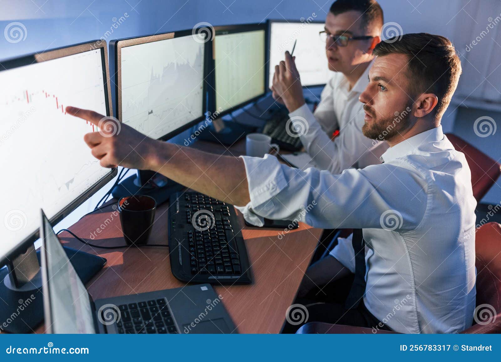 Showing Graph Place. Two Stock Traders Working in the Office with ...