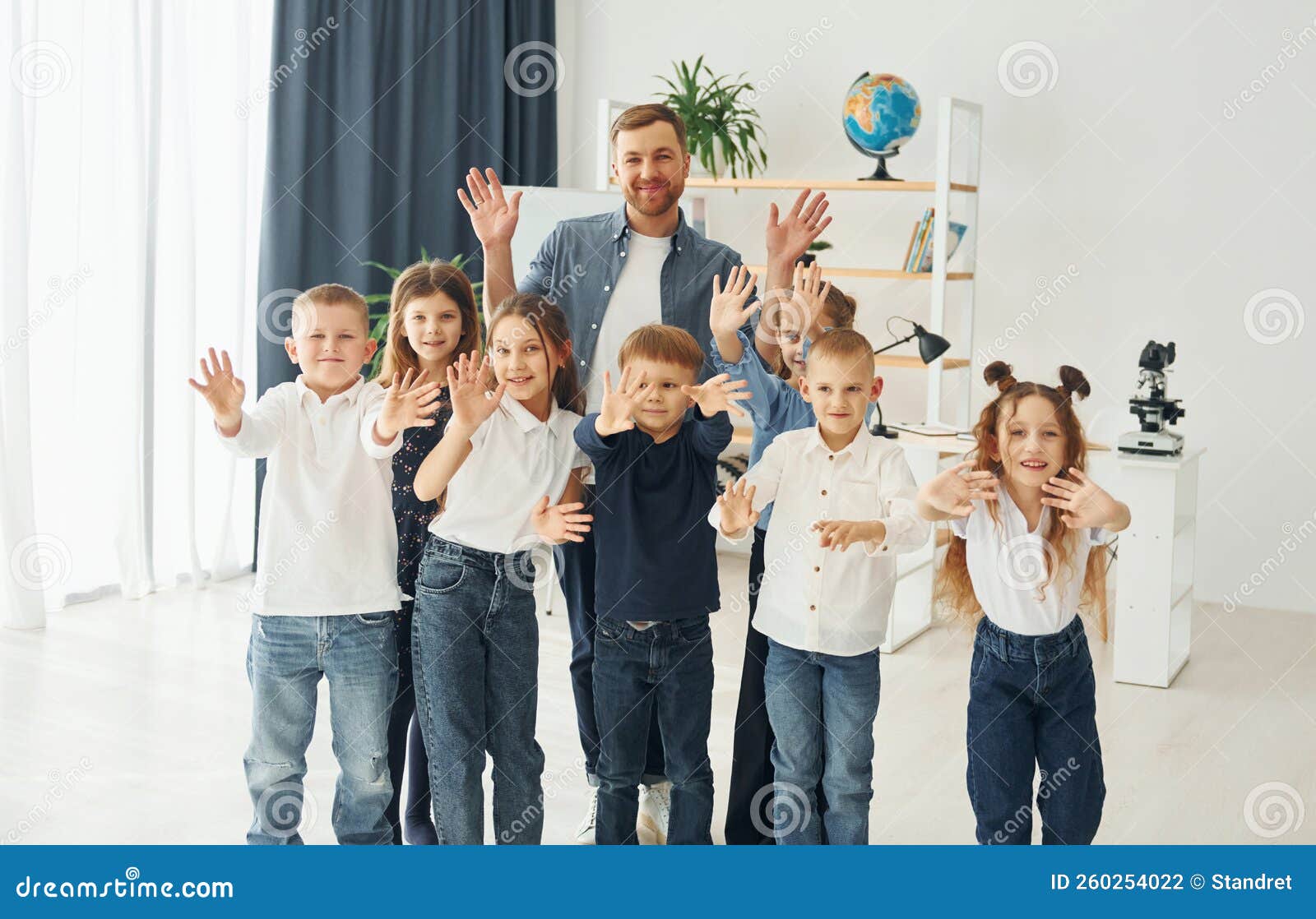 Showing Hello Gestures. Group of Children Students in Class at School ...