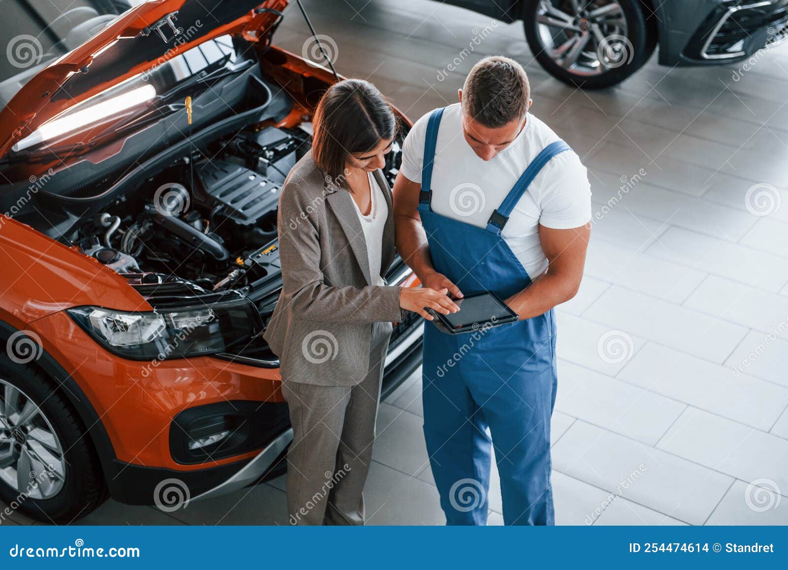 Showing Results of Work. Man Repairing Woman`s Automobile Indoors Stock ... Showing Results of Work. Man Repairing Woman`s Automobile Indoors Stock ...