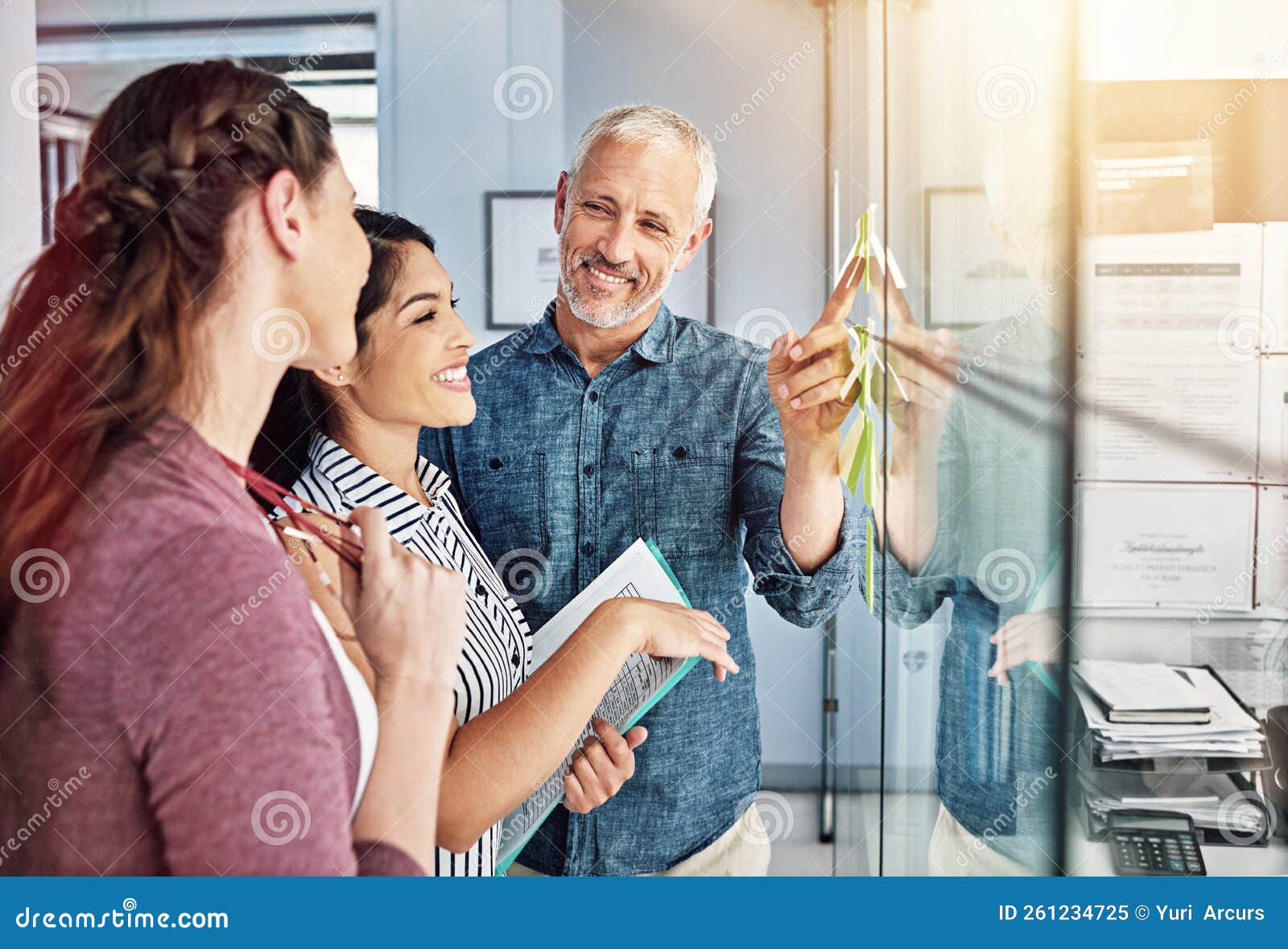 Showing Them the Way Forward. Three Colleagues Looking at Sticky Notes ...