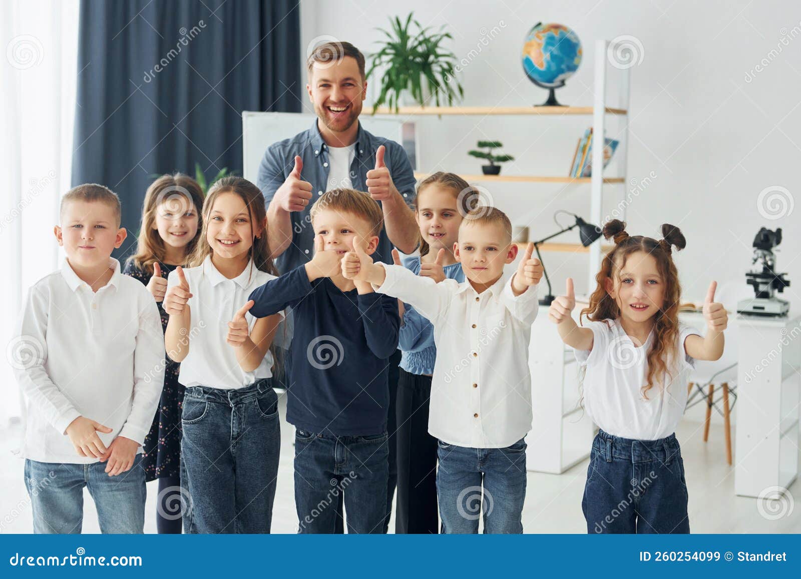 Showing Thumbs Up. Group of Children Students in Class at School with ...
