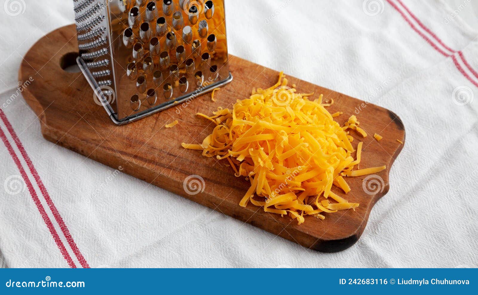 Shredded Sharp Cheddar Cheese on a Rustic Wooden Board, Side View Stock ...
