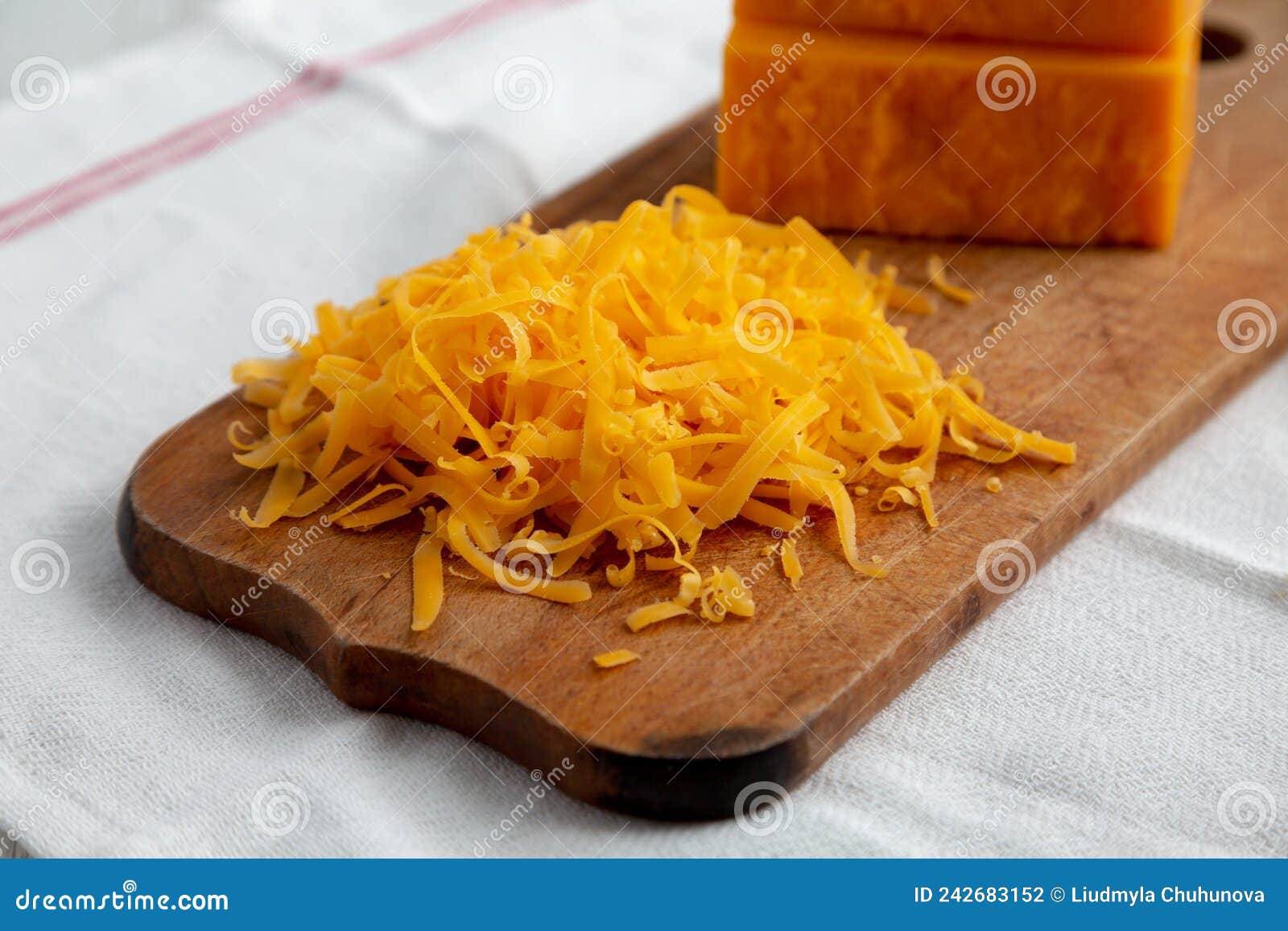 Shredded Sharp Cheddar Cheese on a Rustic Wooden Board, Side View Stock ...