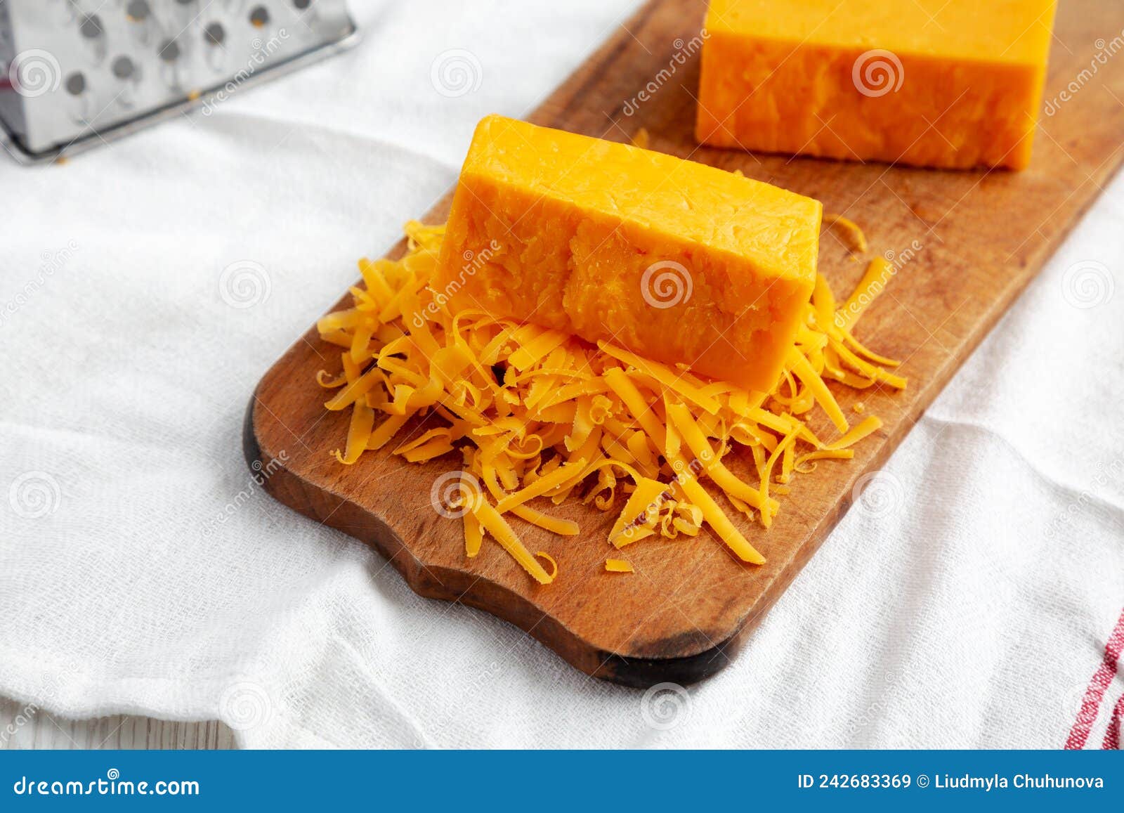 Shredded Sharp Cheddar Cheese on a Rustic Wooden Board, Side View Stock ...