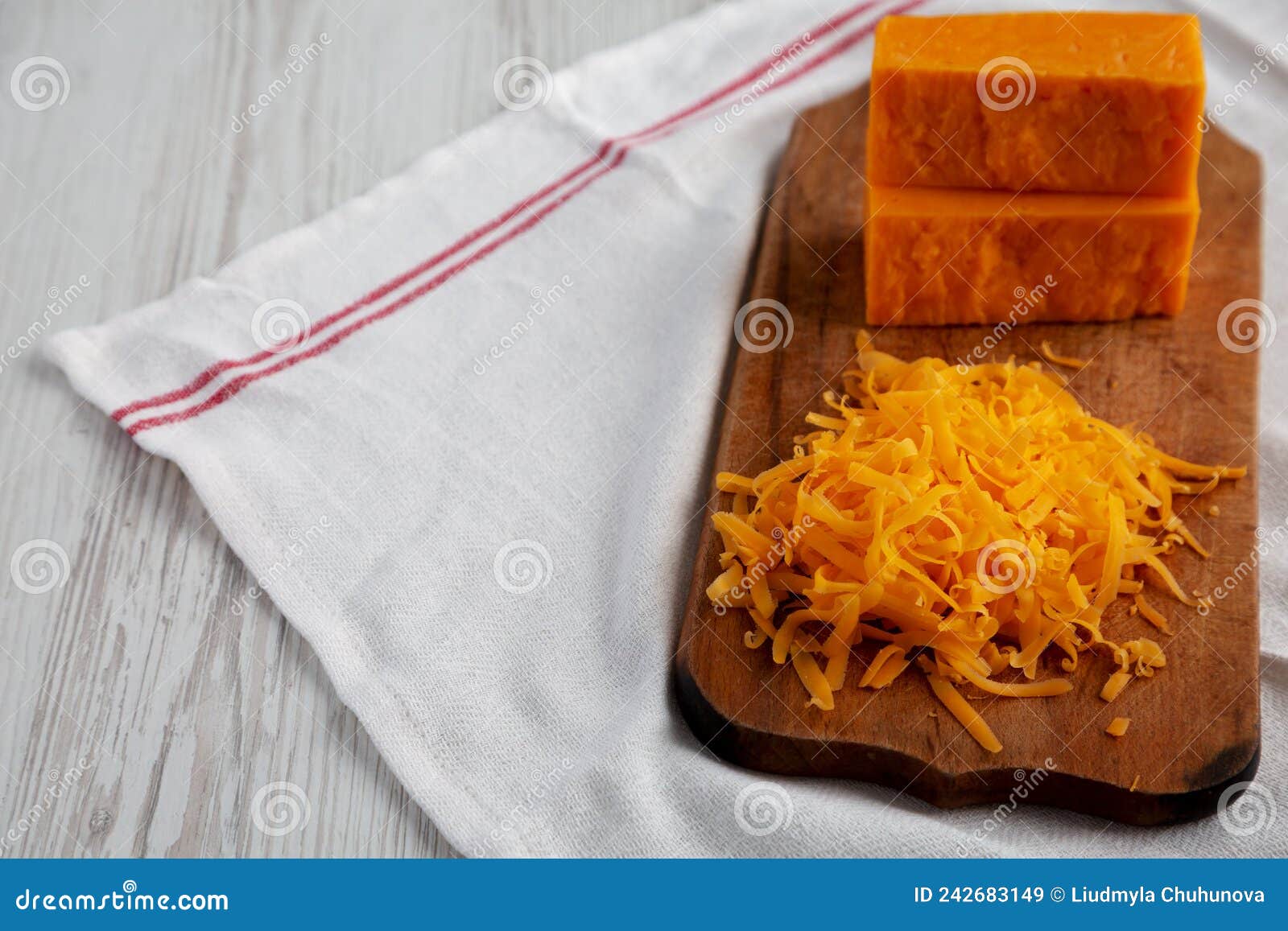 Shredded Sharp Cheddar Cheese on a Rustic Wooden Board, Side View ...