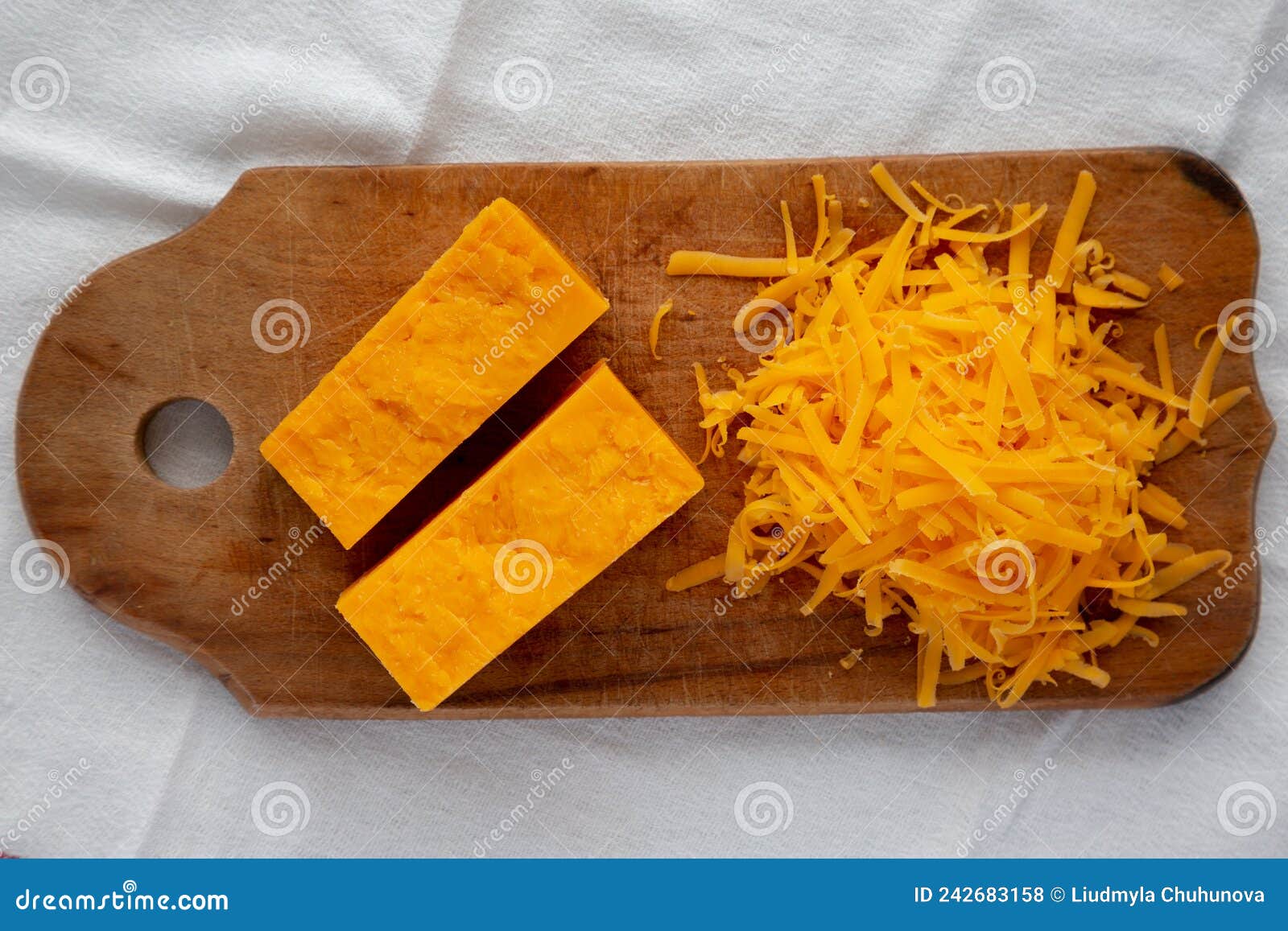 Shredded Sharp Cheddar Cheese on a Rustic Wooden Board, Top View. Flat ...