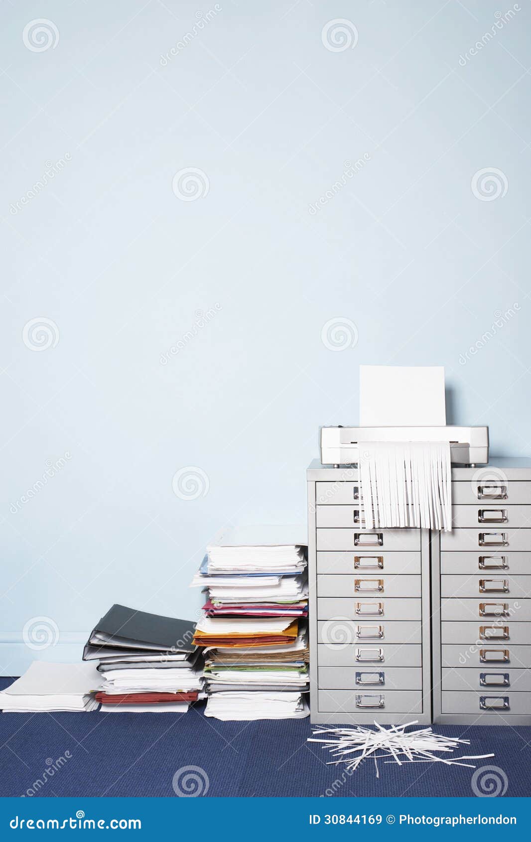Shredder on File Cabinet Stack of Paperwork on Floor in Office Stock ...